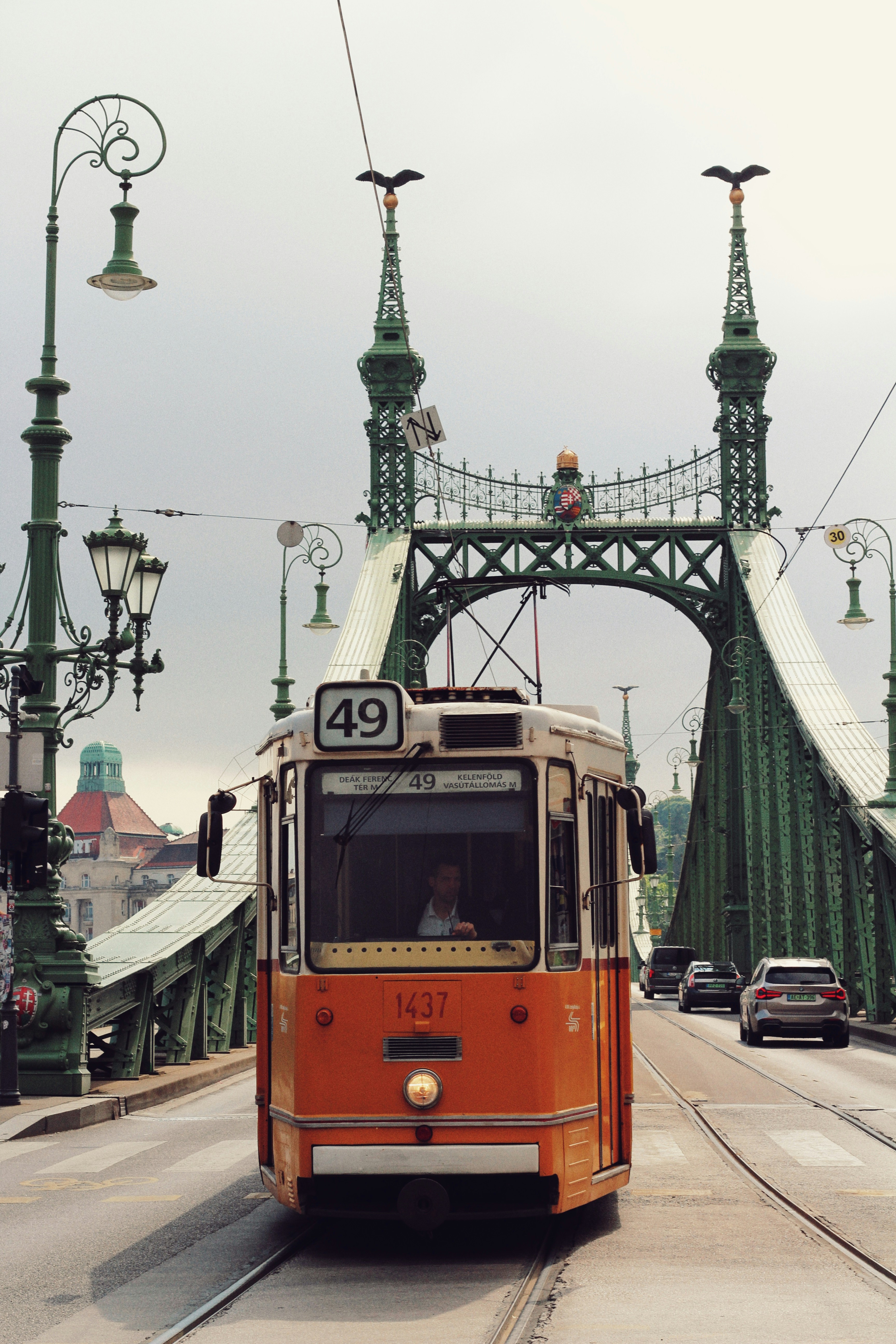 Momentum on the Green Iron: orange tram crossing a historic bridge