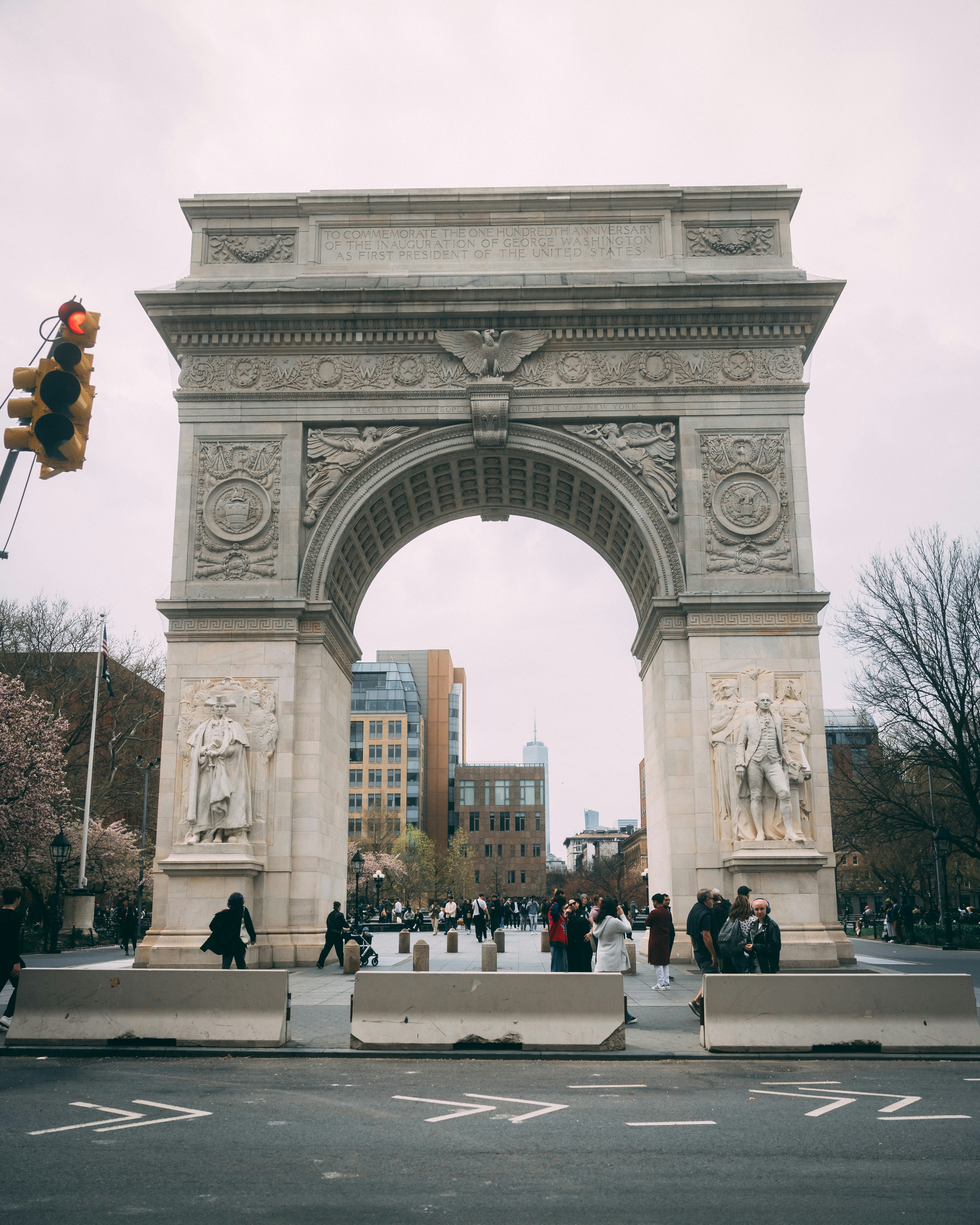 A group of people standing in front of a stone arch photo – Free ...