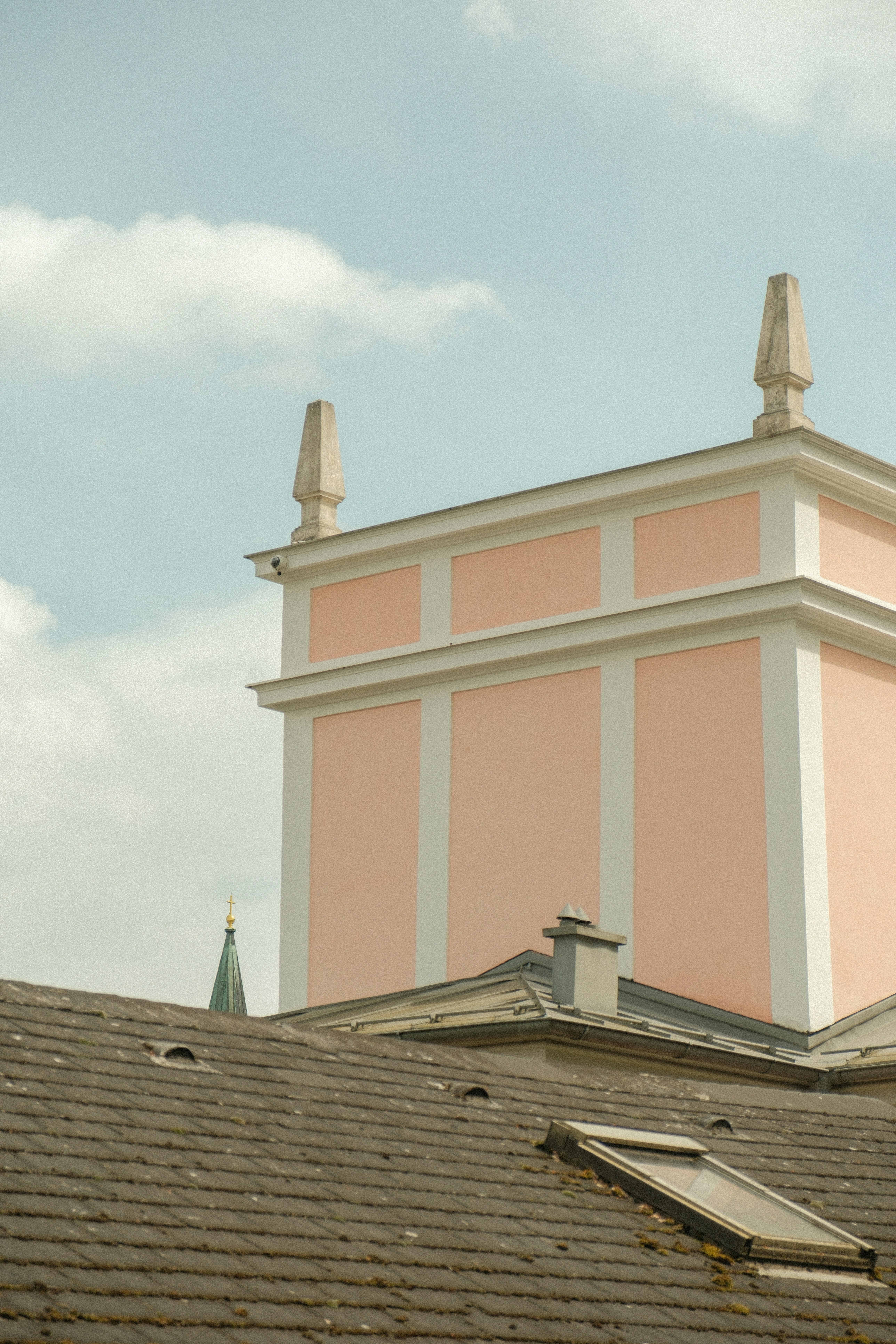 Pastel Facade Above Slate Roof: A Rooftop Geometry Study