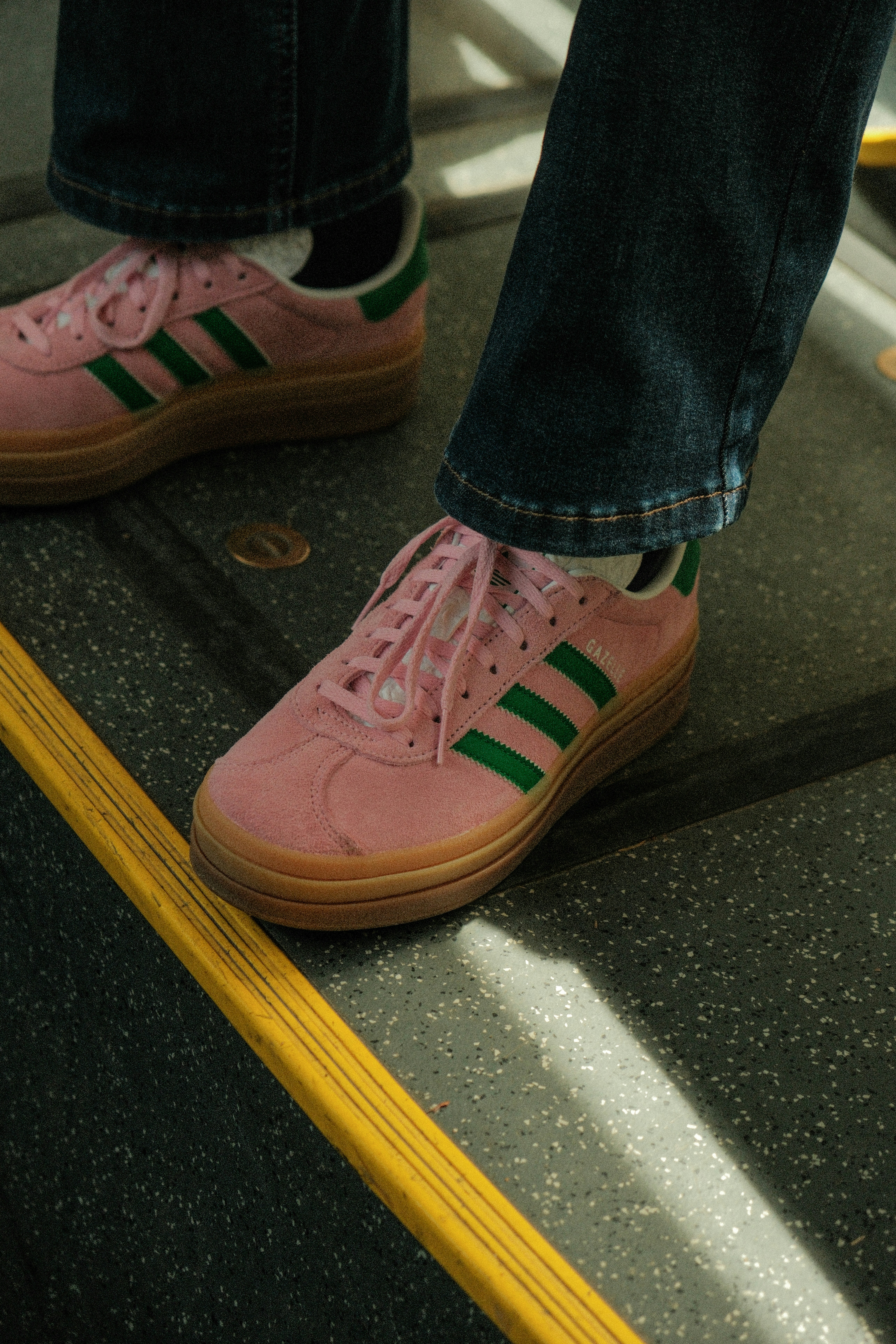a pair of pink adidas sneakers with green stripesAlex Presa