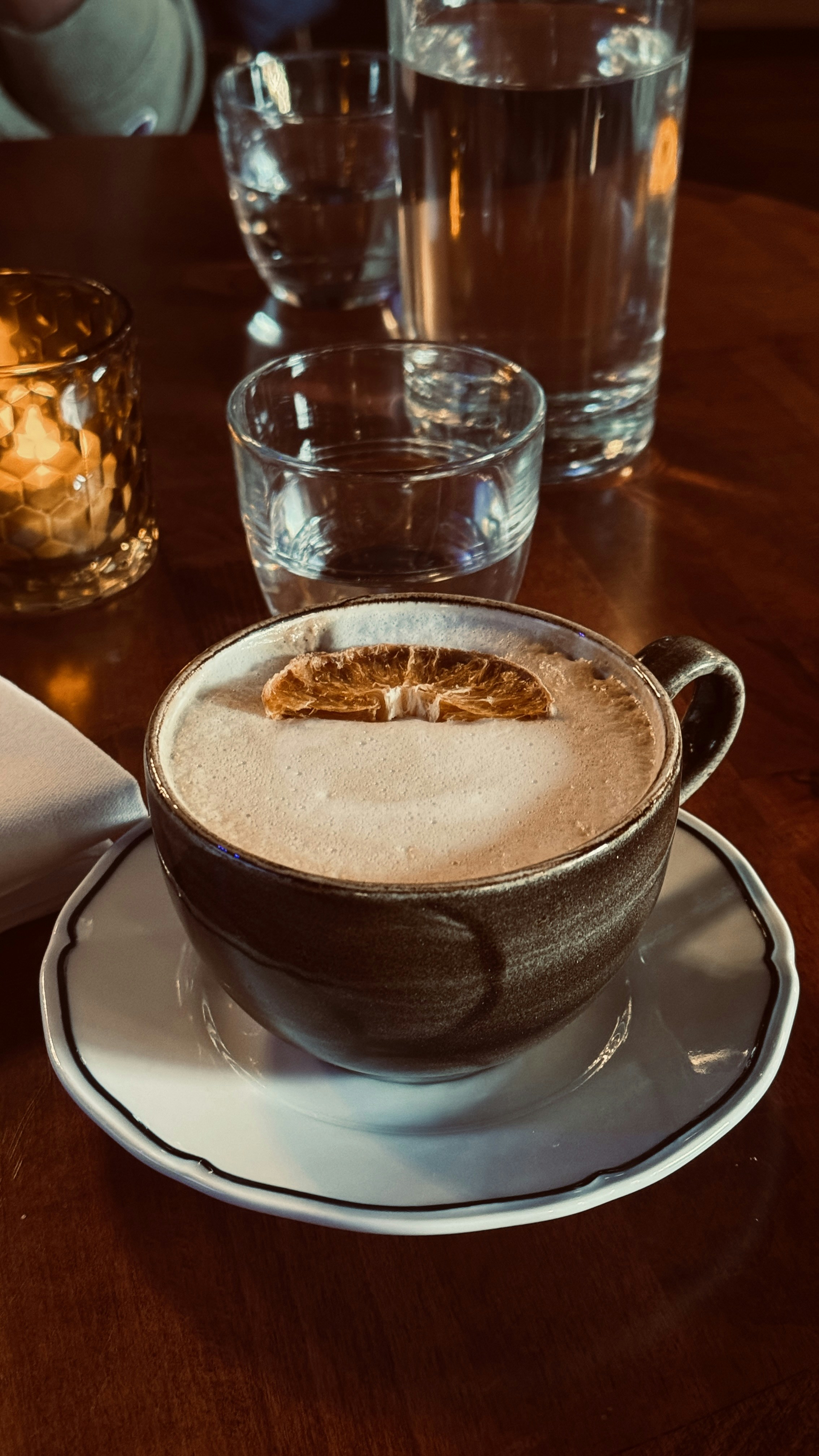 Cup of Warmth: A Cocoa-Cream Moment at a Cafe Table
