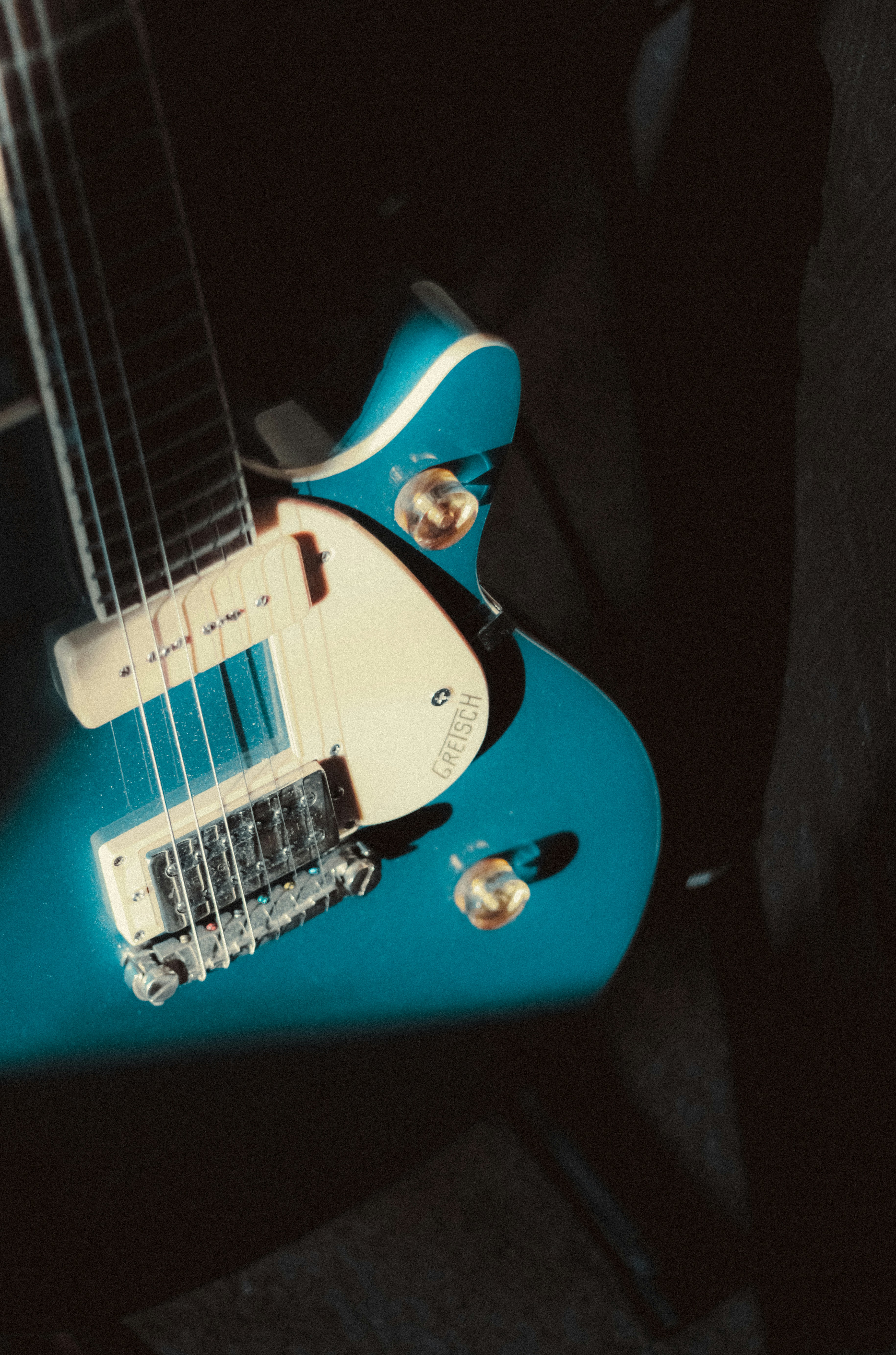 Blue Gretsch-Style Electric Guitar in Dim Stage Light