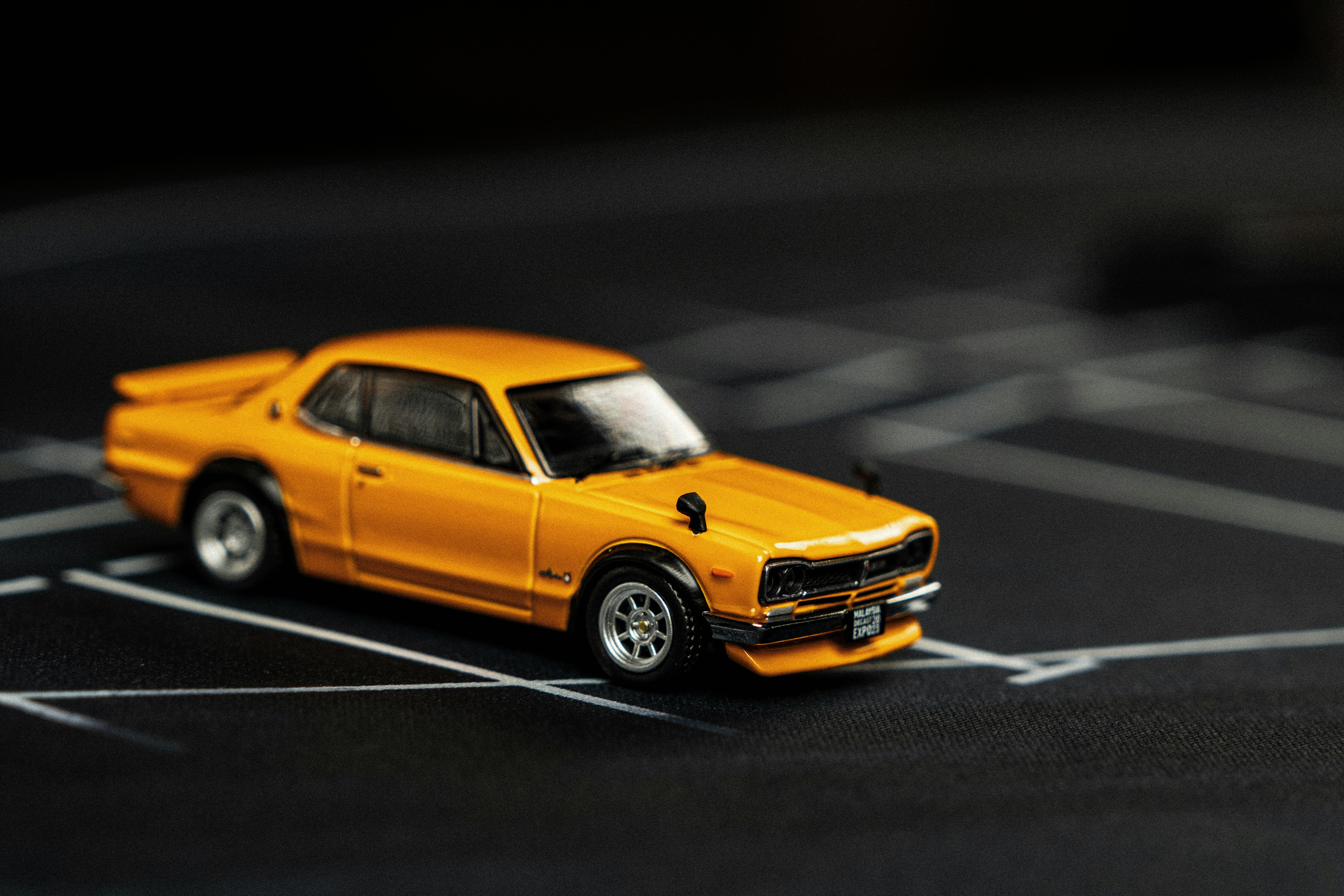Mini Mustang in Focus: A Yellow Model Car Starring in a Parking Lot Studio
