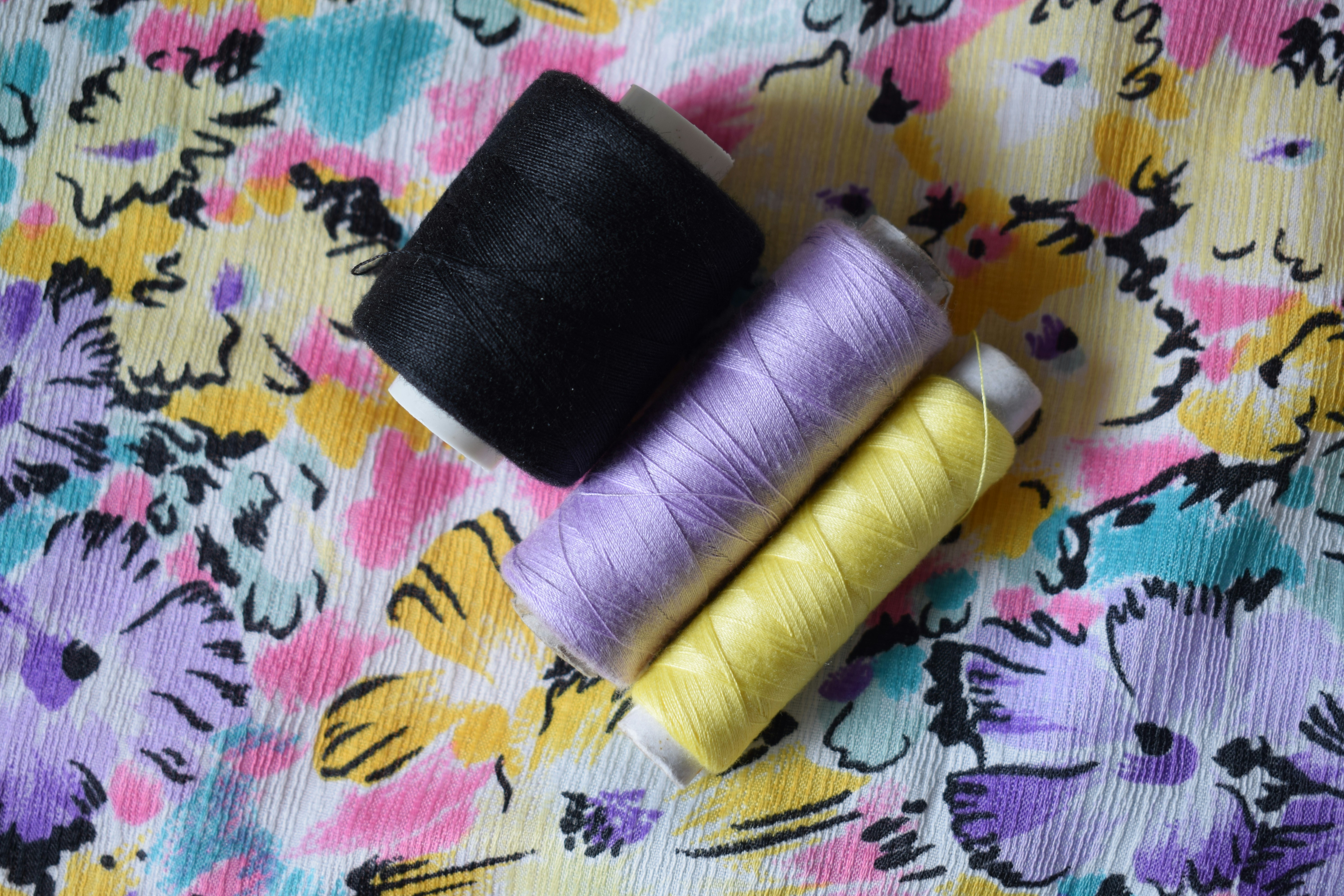Spools of Thread on Colorful Floral Fabric