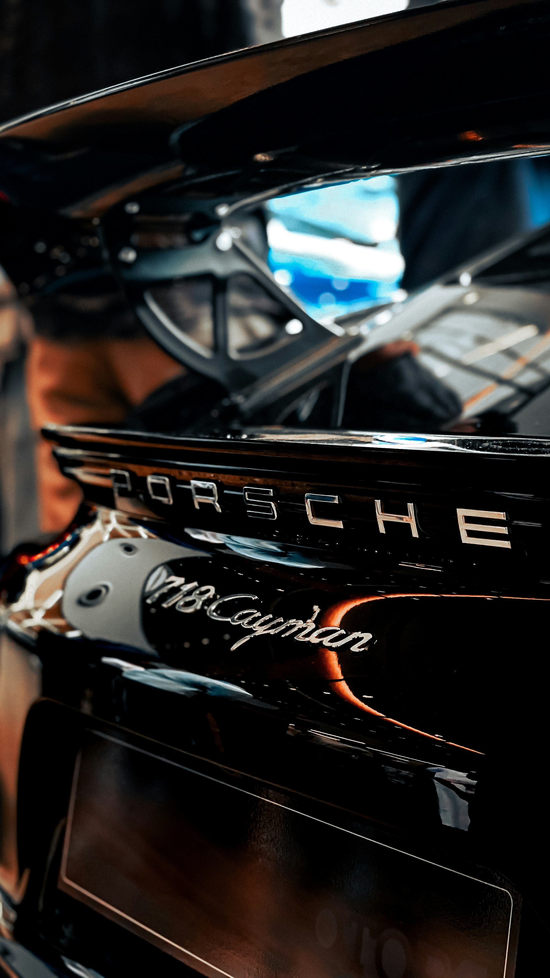 Chrome Emblem, Midnight Shine: A Porsche Macan’s Badge in Focus