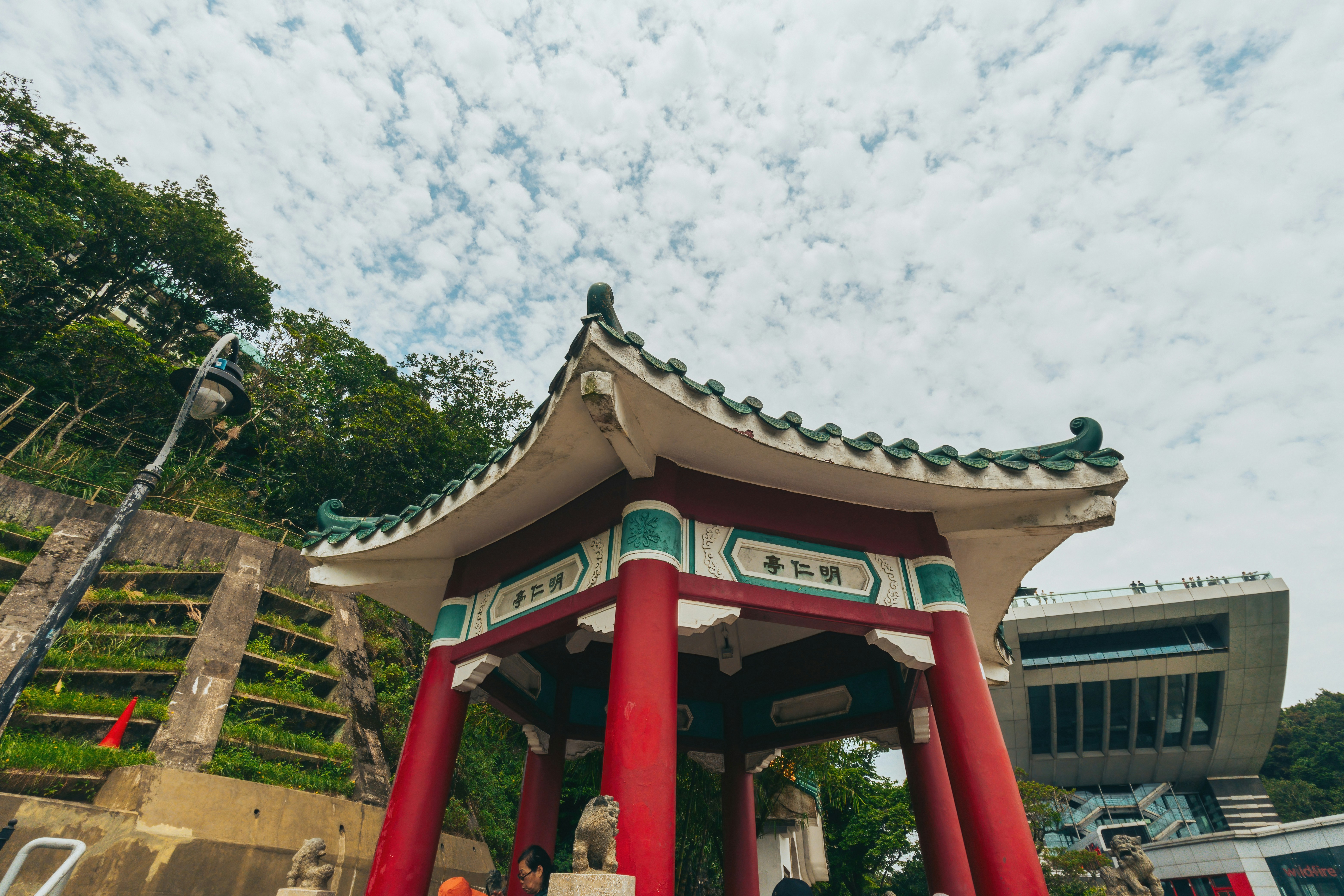 Crimson Pavilion Beneath a Cloud-Laced Sky