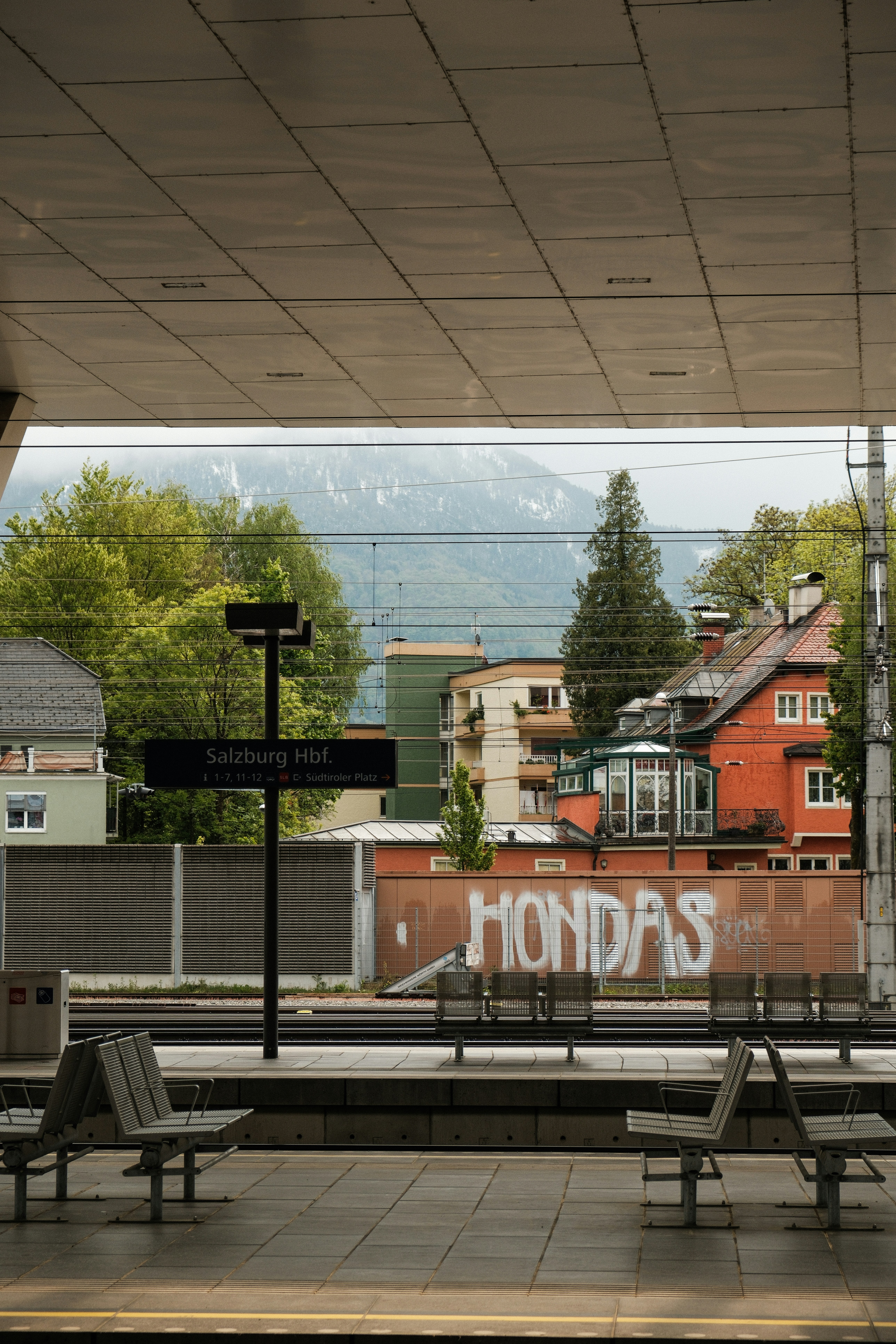 Honda Graffiti on a Quiet Salzburg Platform Framed by Alpine Backdrop