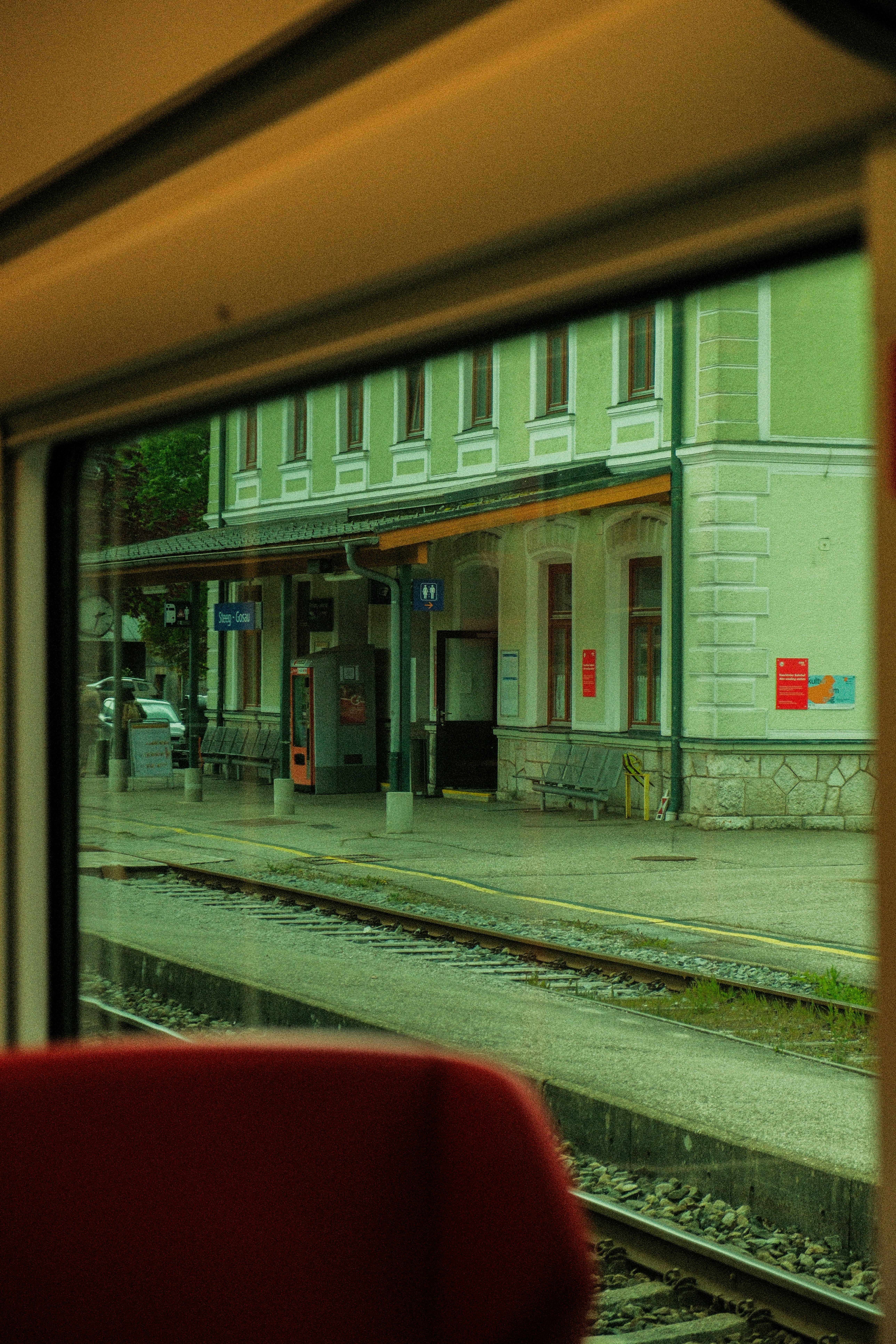 Platform Perspective: Emerald Facade Framed by a Train Window