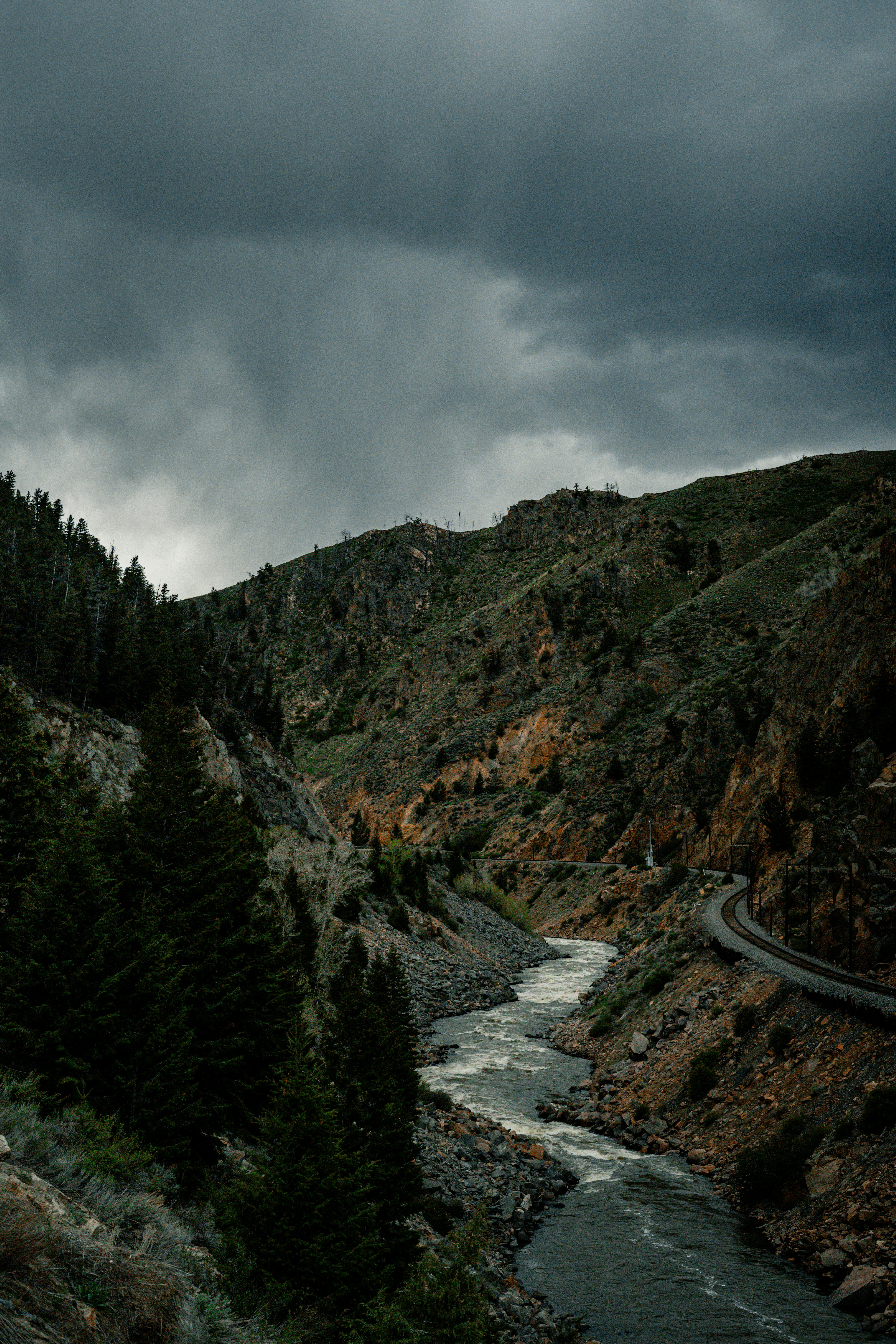 Storm-Tempered Gorge: A Winding Road Beside a Rushing Mountain River
