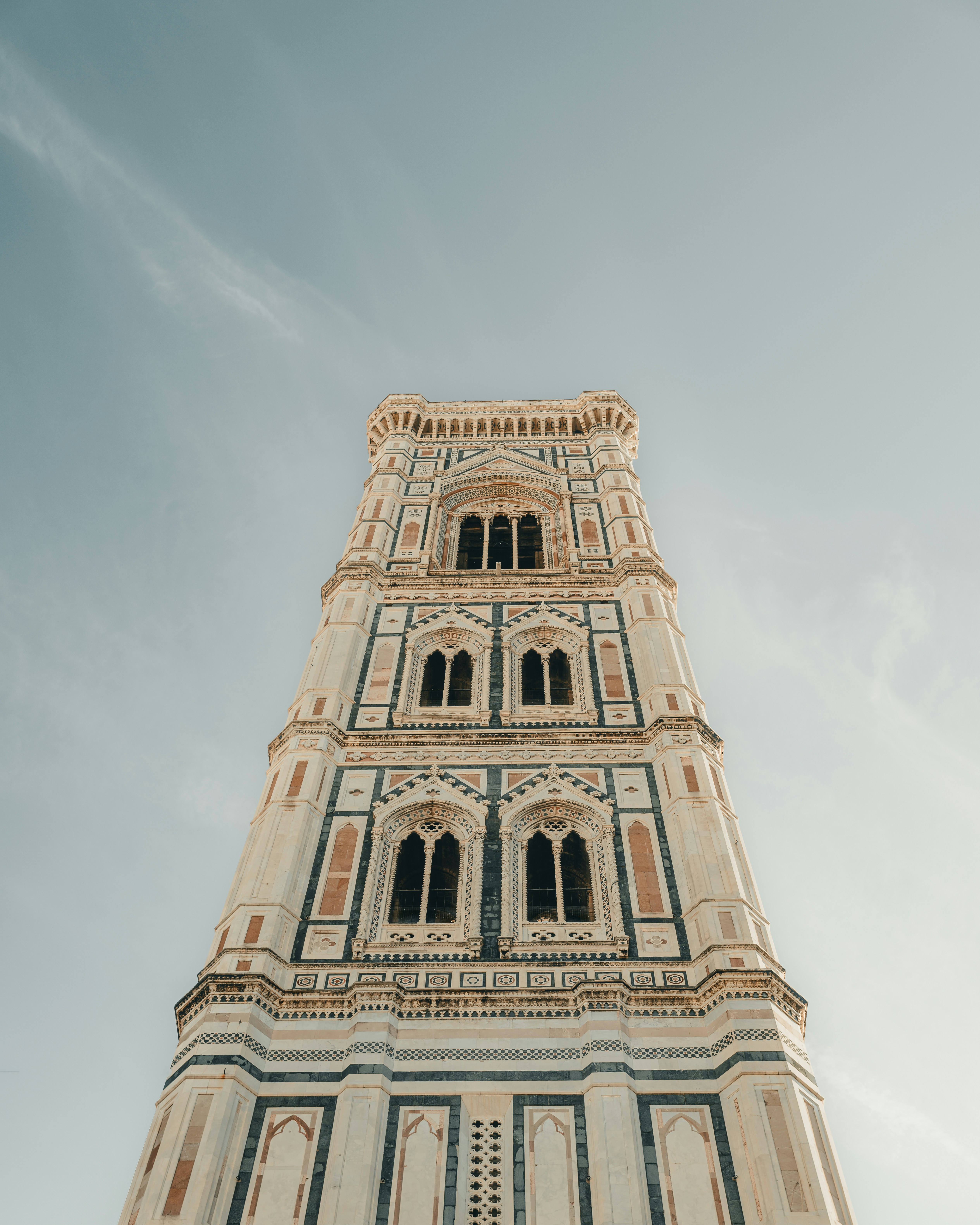 Marble Stripes Ascend: Giotto's Campanile under a Pale Blue Sky