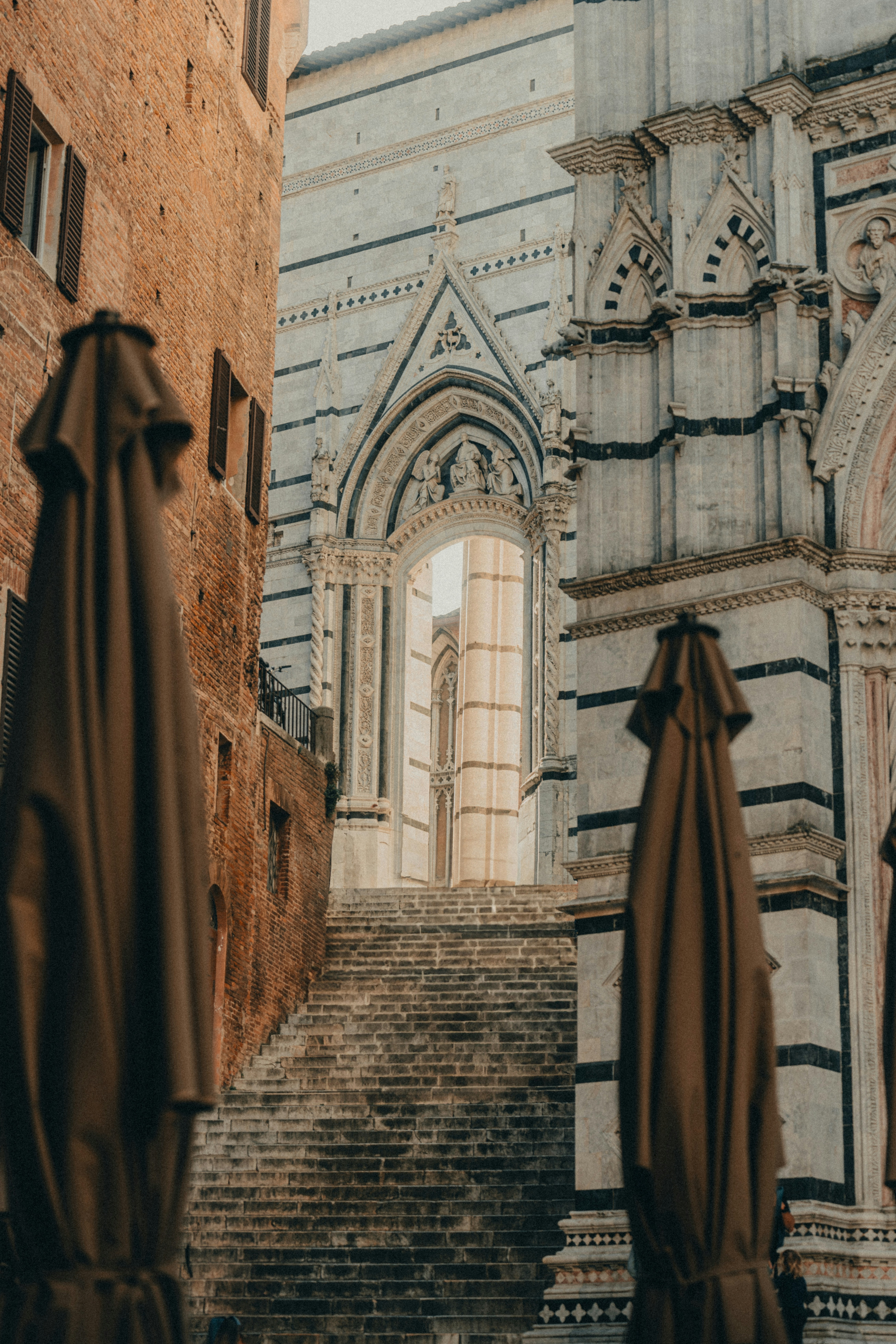 Steps Toward the Gothic Portal: Marble Facade Framed by Shadowed Staircase