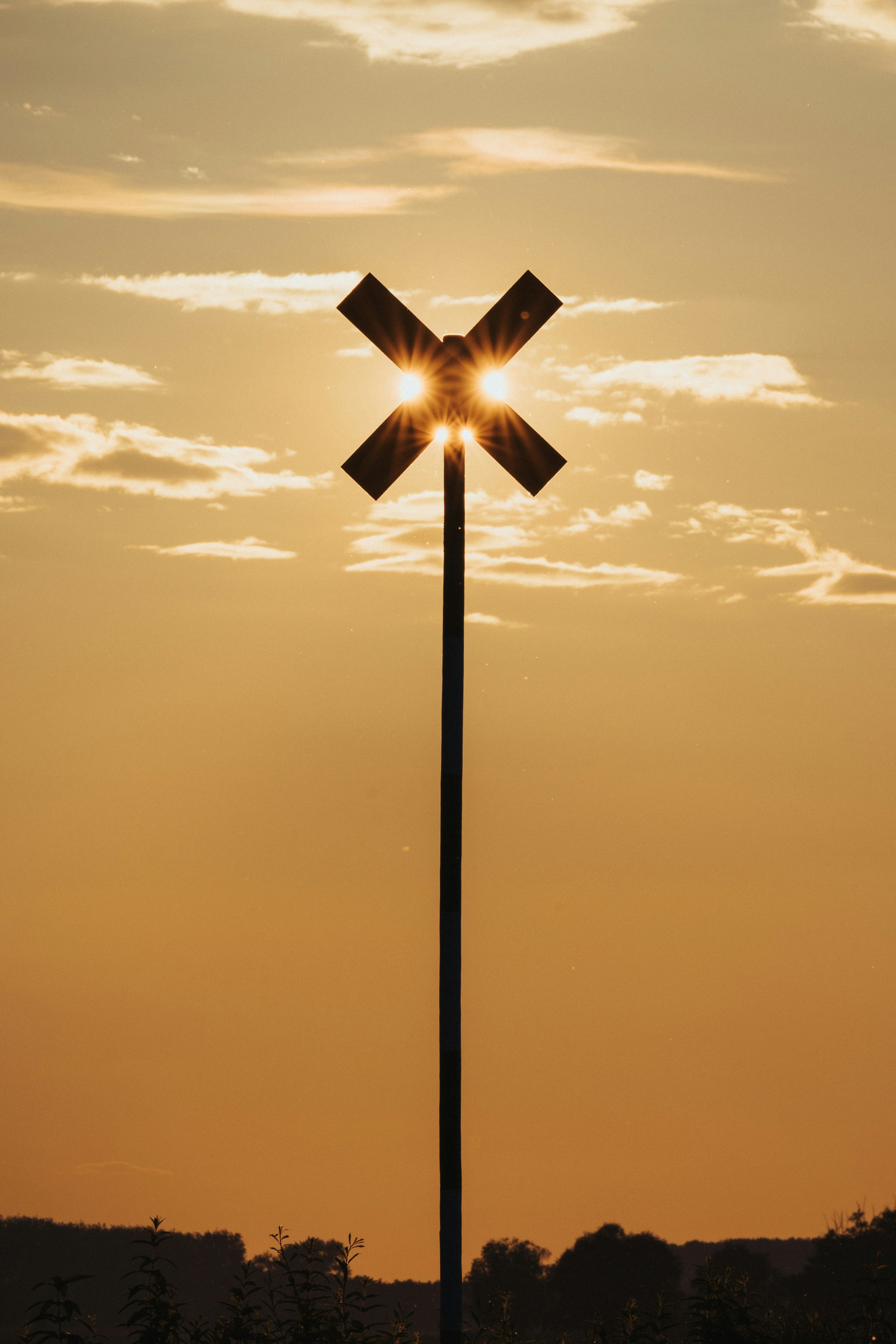 A pole with a cross on it in the middle of a field photo – Free Sunset ...