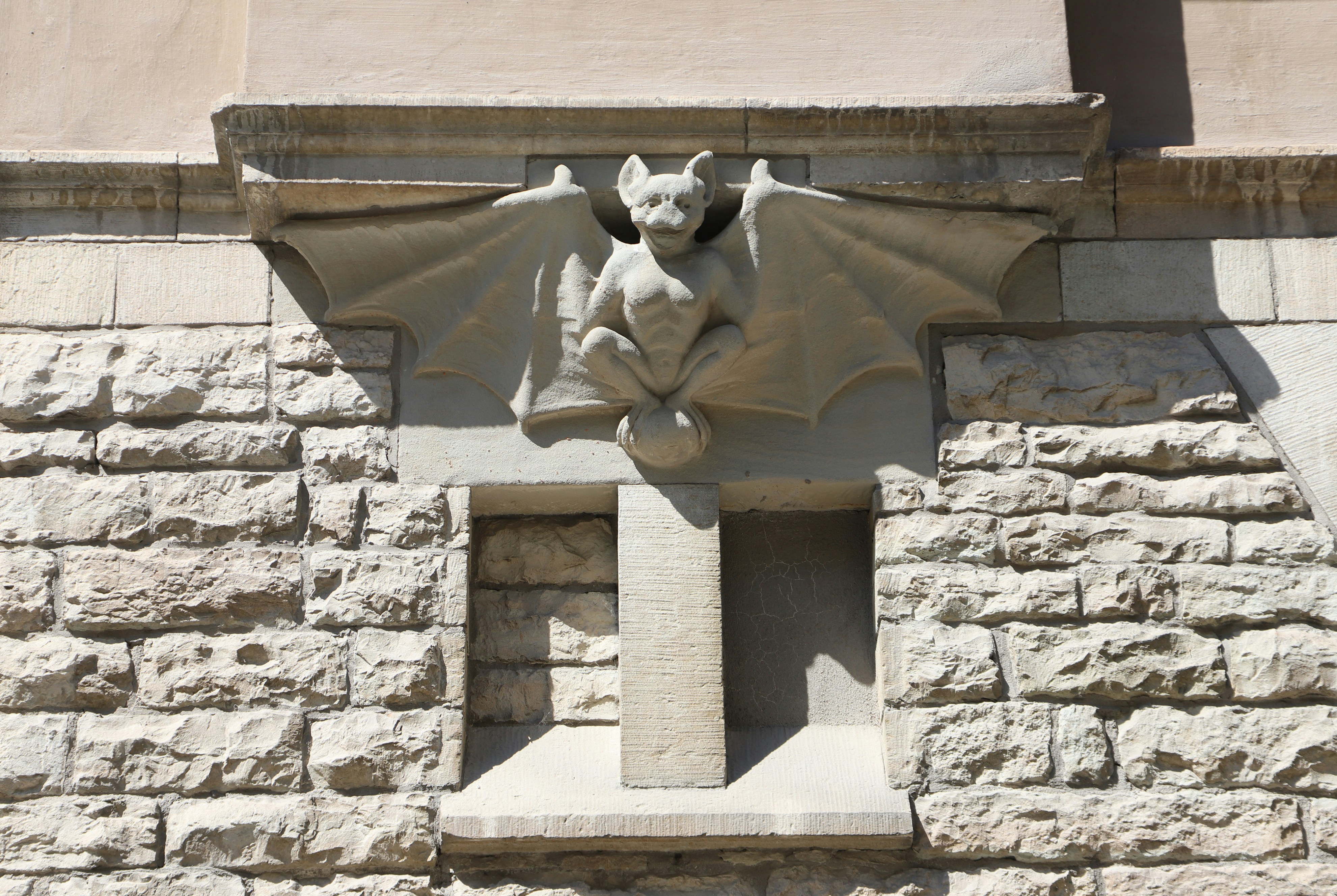 Winged Gargoyle Sentinel Over a Stone Window Niche