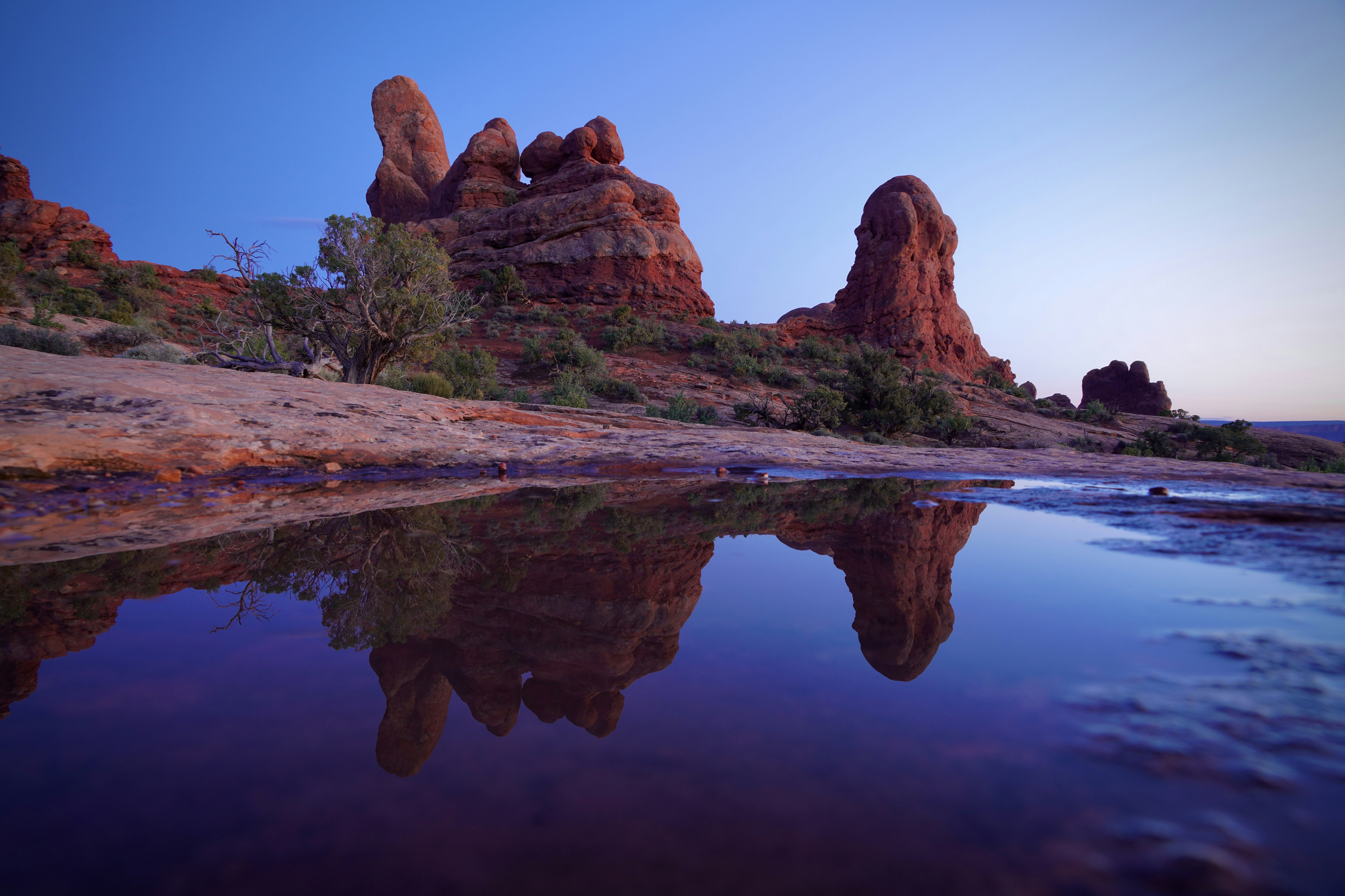 A body of water with rocks in the background photo – Free Usa Image on ...