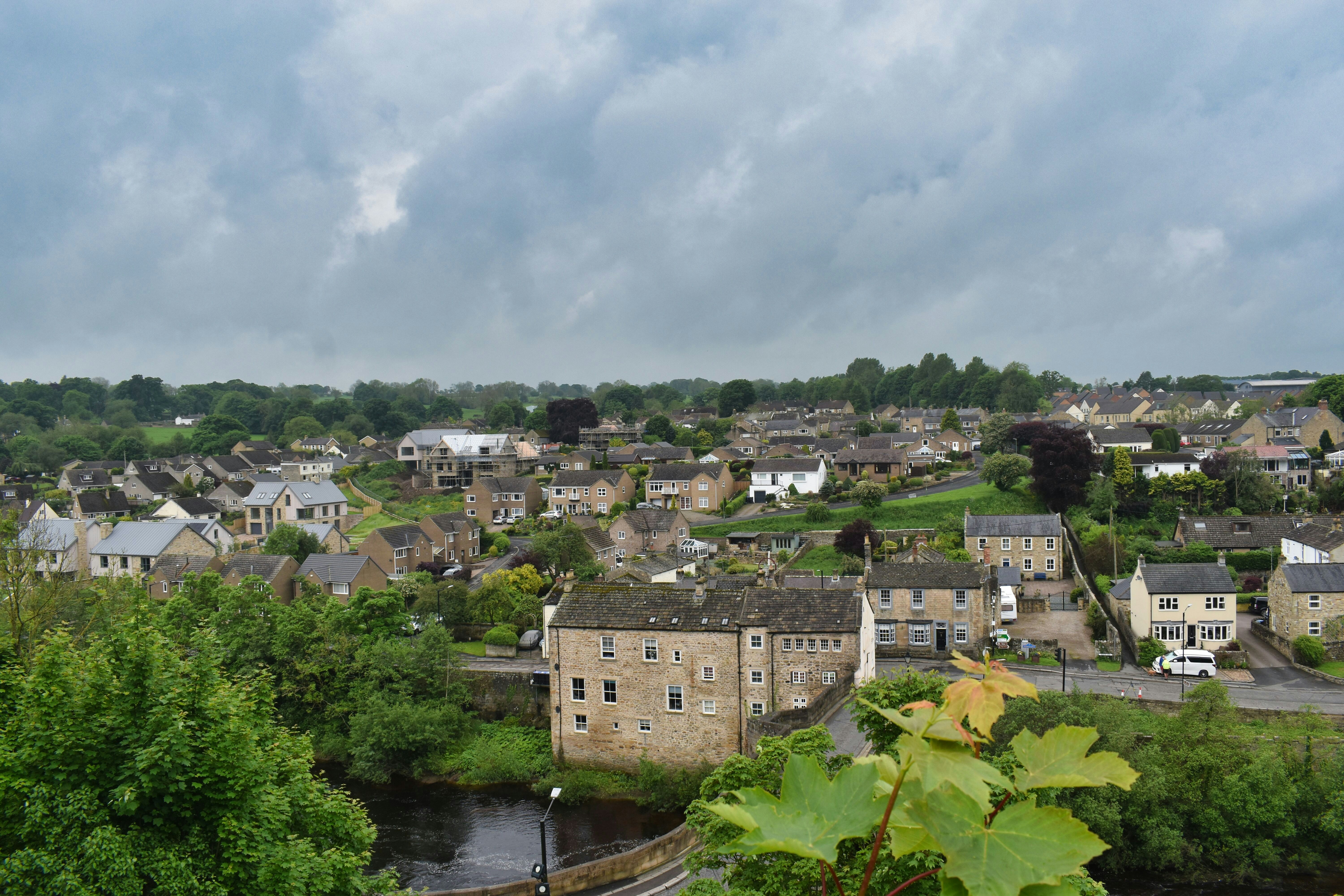 Riverside Stone Village Under a Moody, Overcast Sky