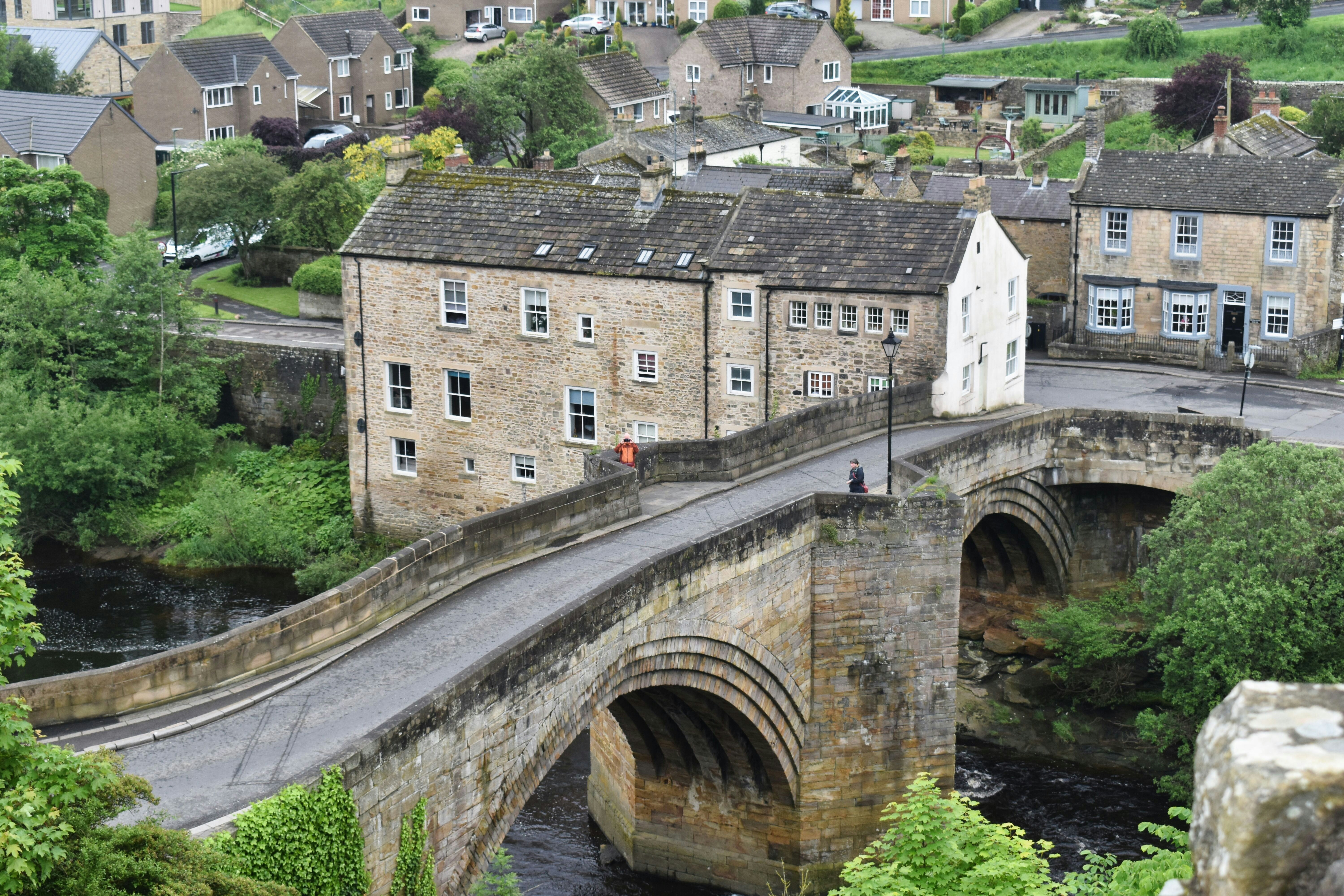 Stone-Arched Bridge and Verdant Village: A Quiet Path Through Time