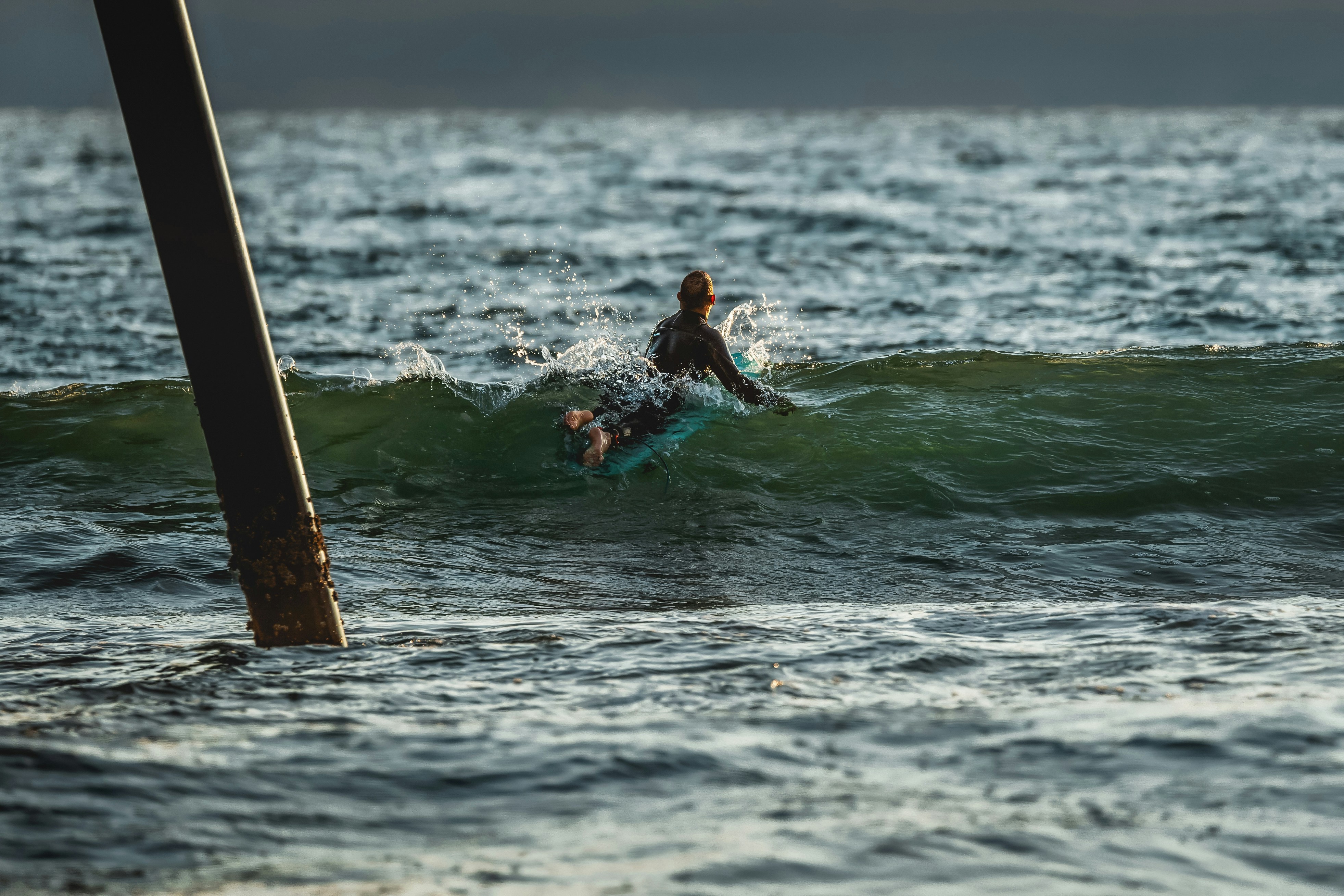 Waiting... | a person riding a surfboard on a wave in the ocean