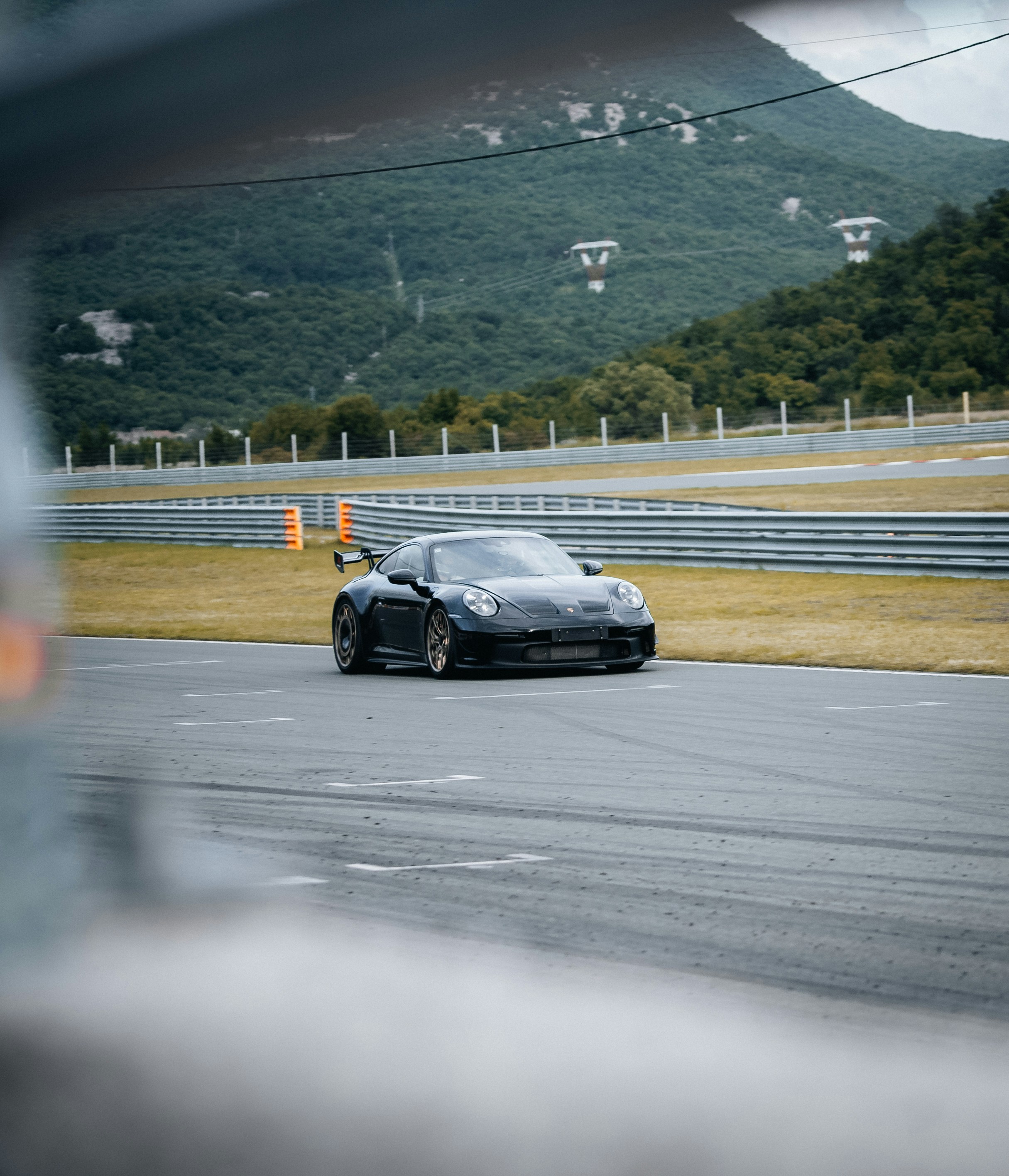 A black sports car driving down a race track photo – Free Porsche 911 ...
