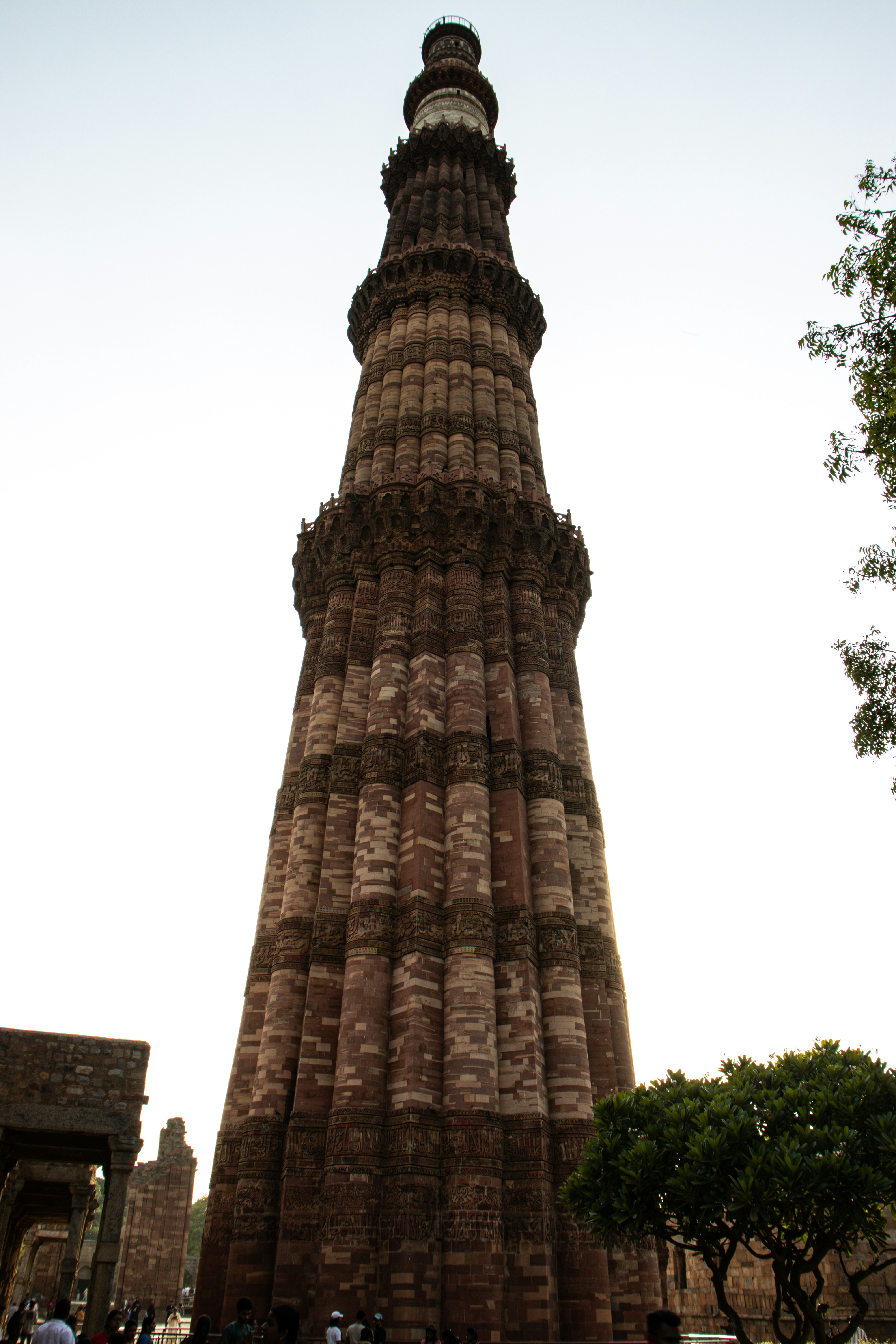 Qutub Minar: Brick Spiral Rising into a Pale Sky
