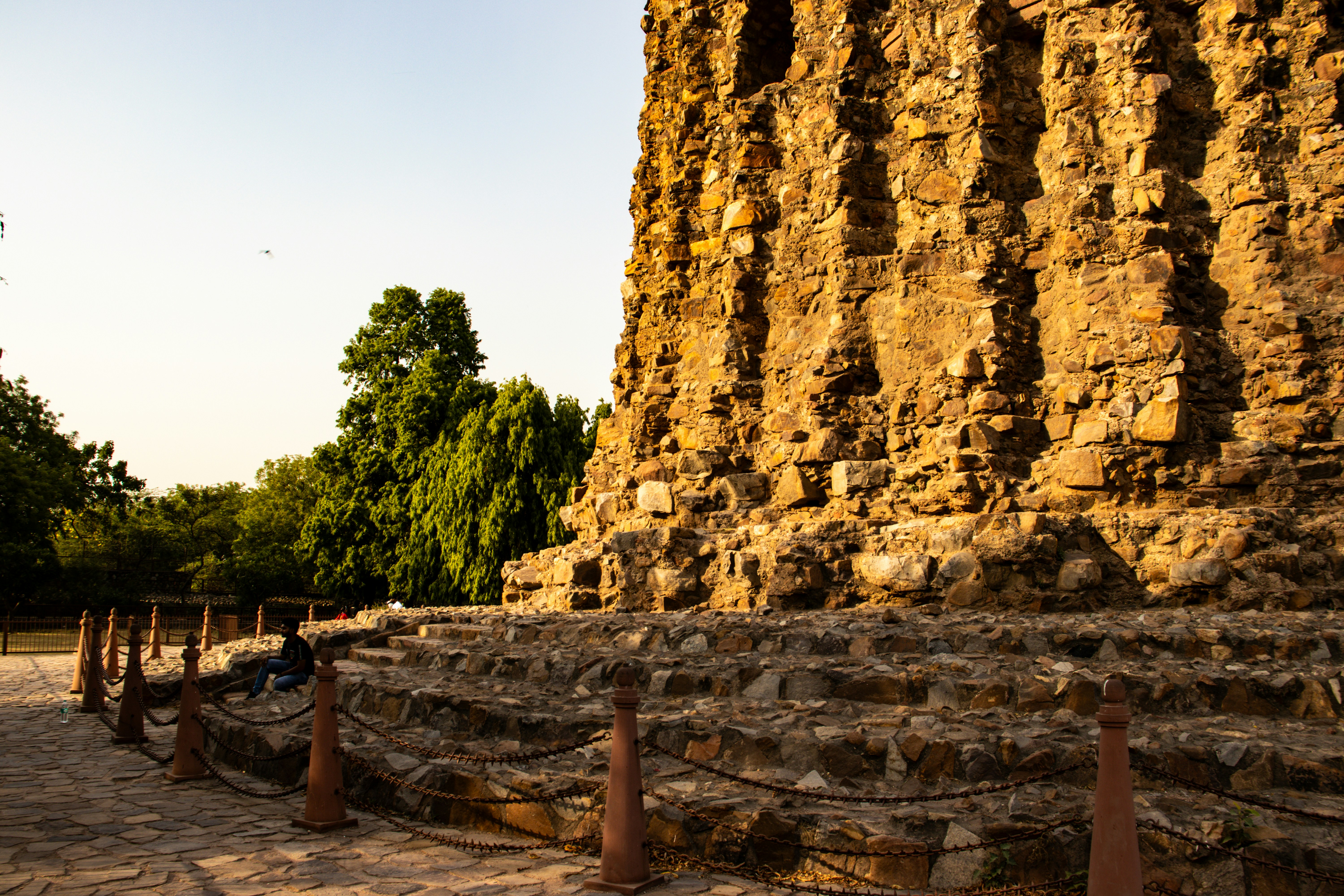Sunlit Strata: Weathered Stones at the Tower's Base