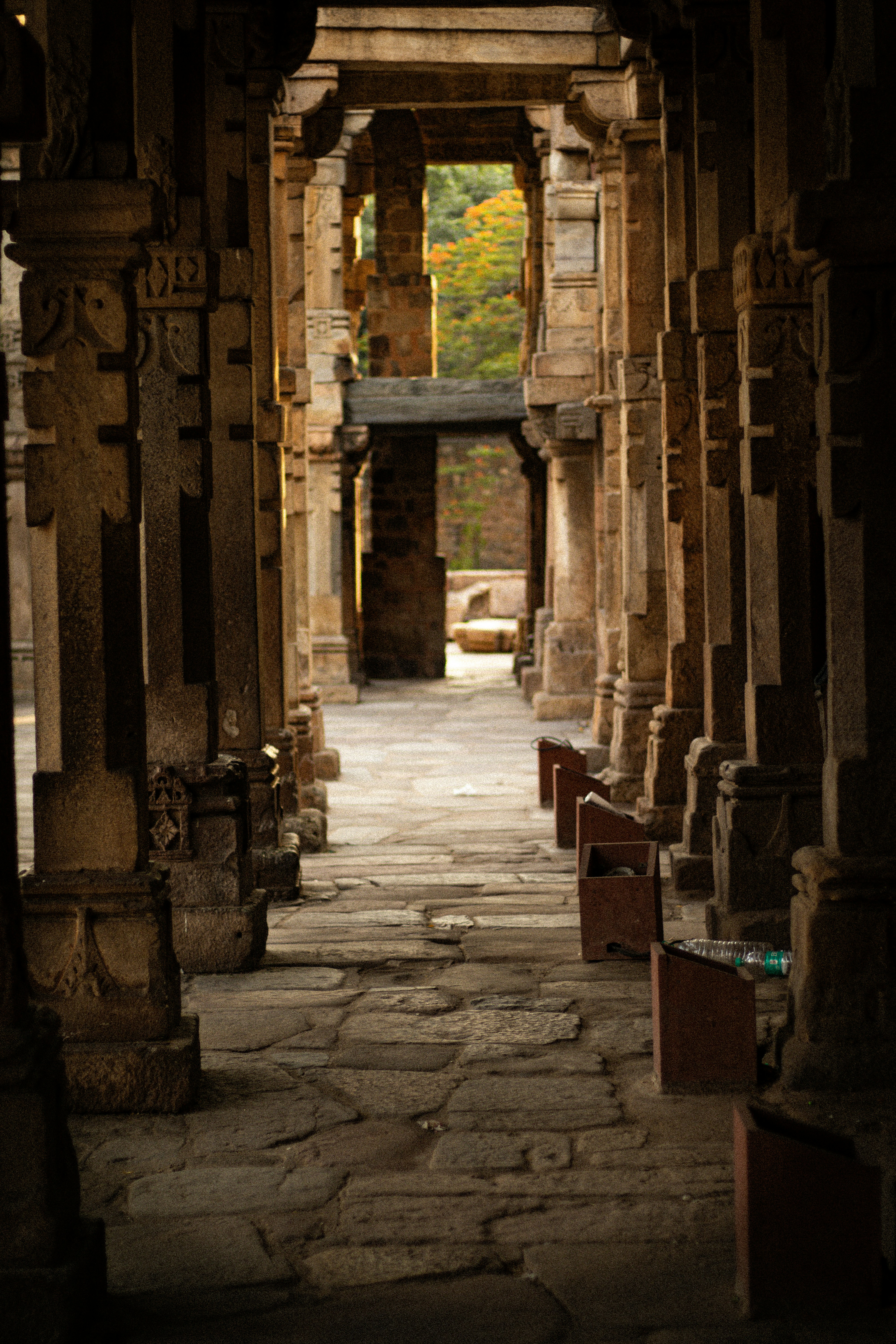 Light at the End of the Corridor: Sunlit Chapel Columns Framing a Golden Exit