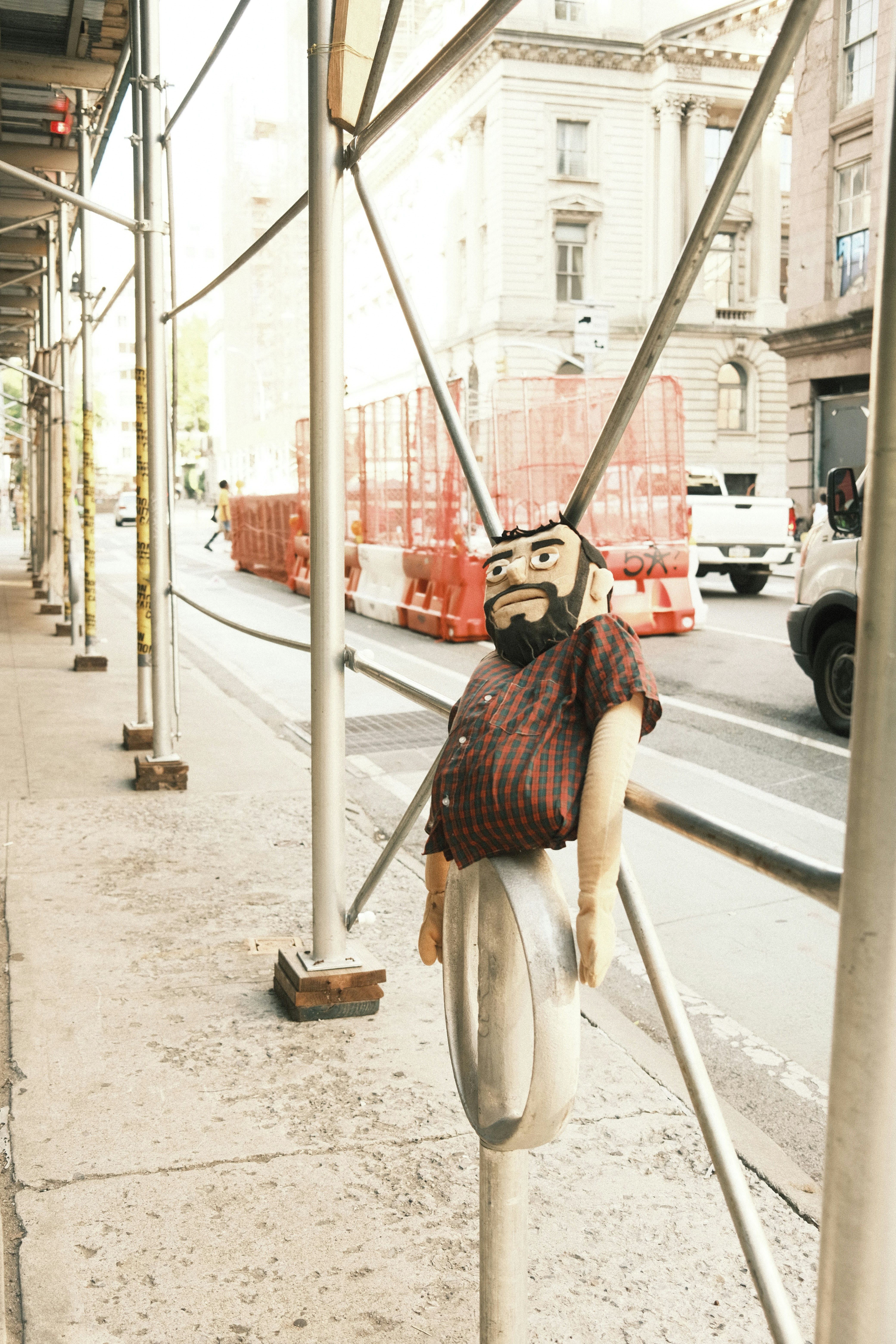 Mask and Scaffold: A Curious Figure Anchored on a City Street