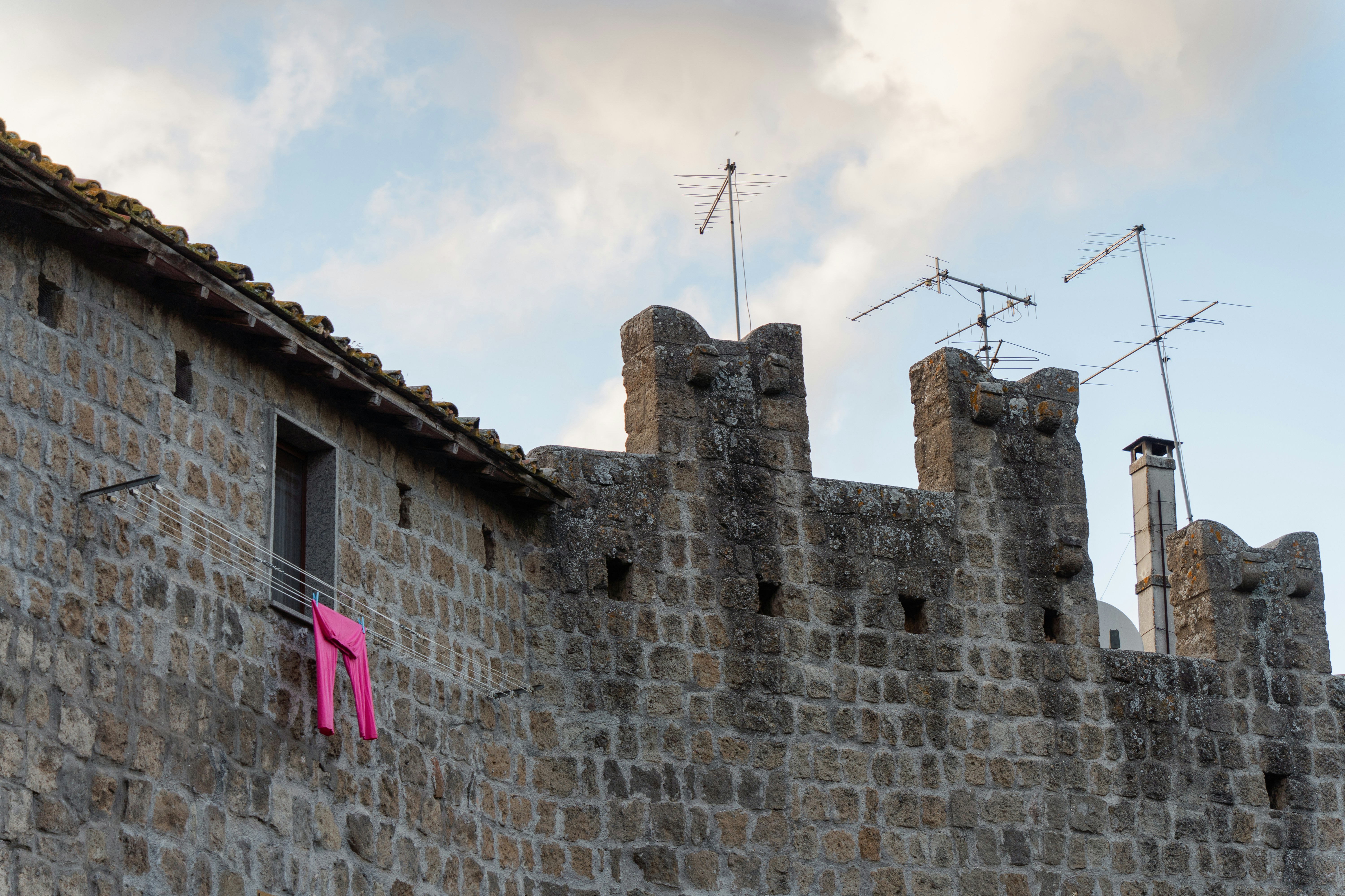 Pink Garment on a Sunlit Fortress Wall