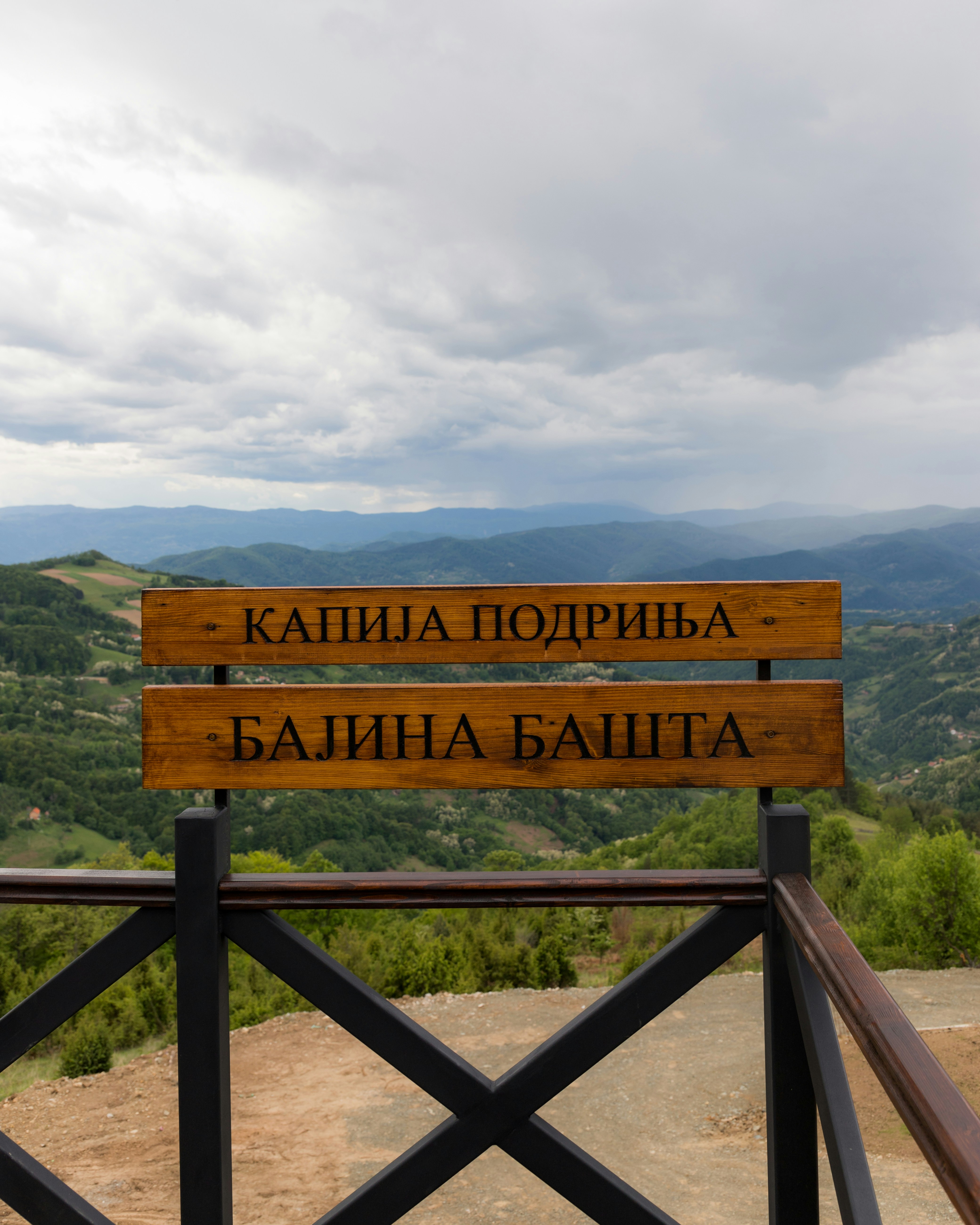 Wooden Signpost Overlooking Rolling Hills