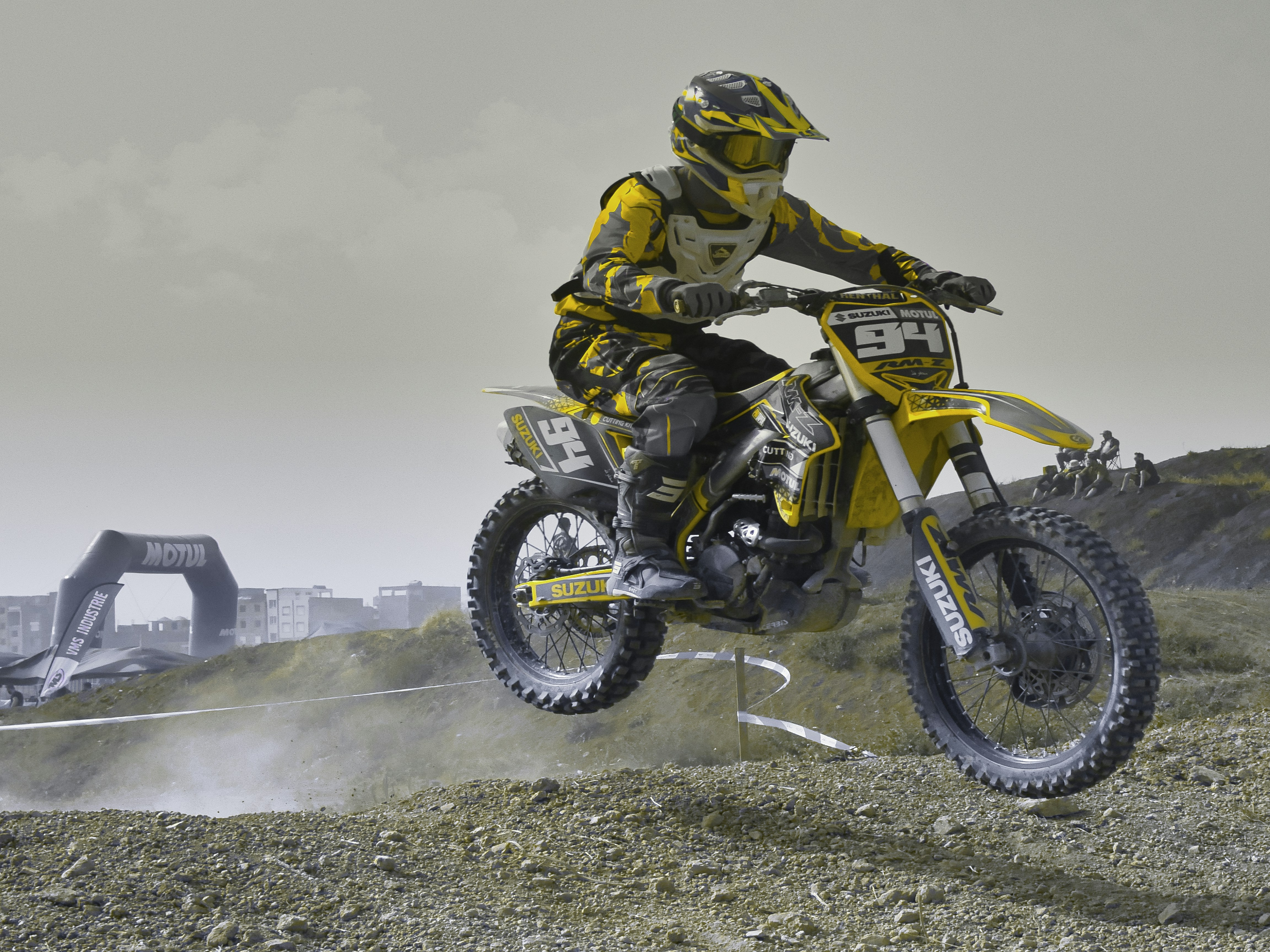 Golden Gear in Midair: Motocross Rider Cleans the Dust