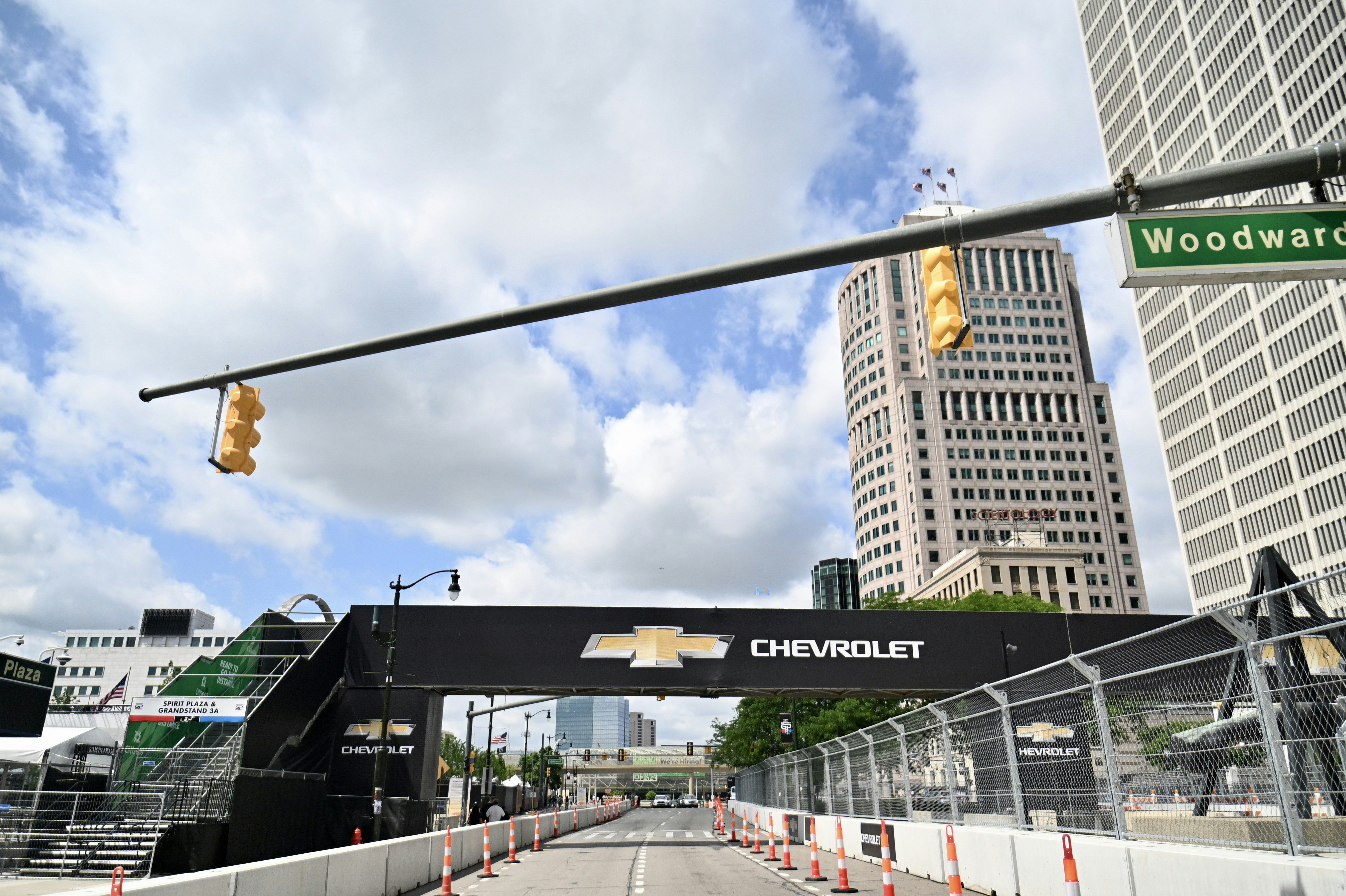 A traffic light hanging over a street next to a tall building photo ...
