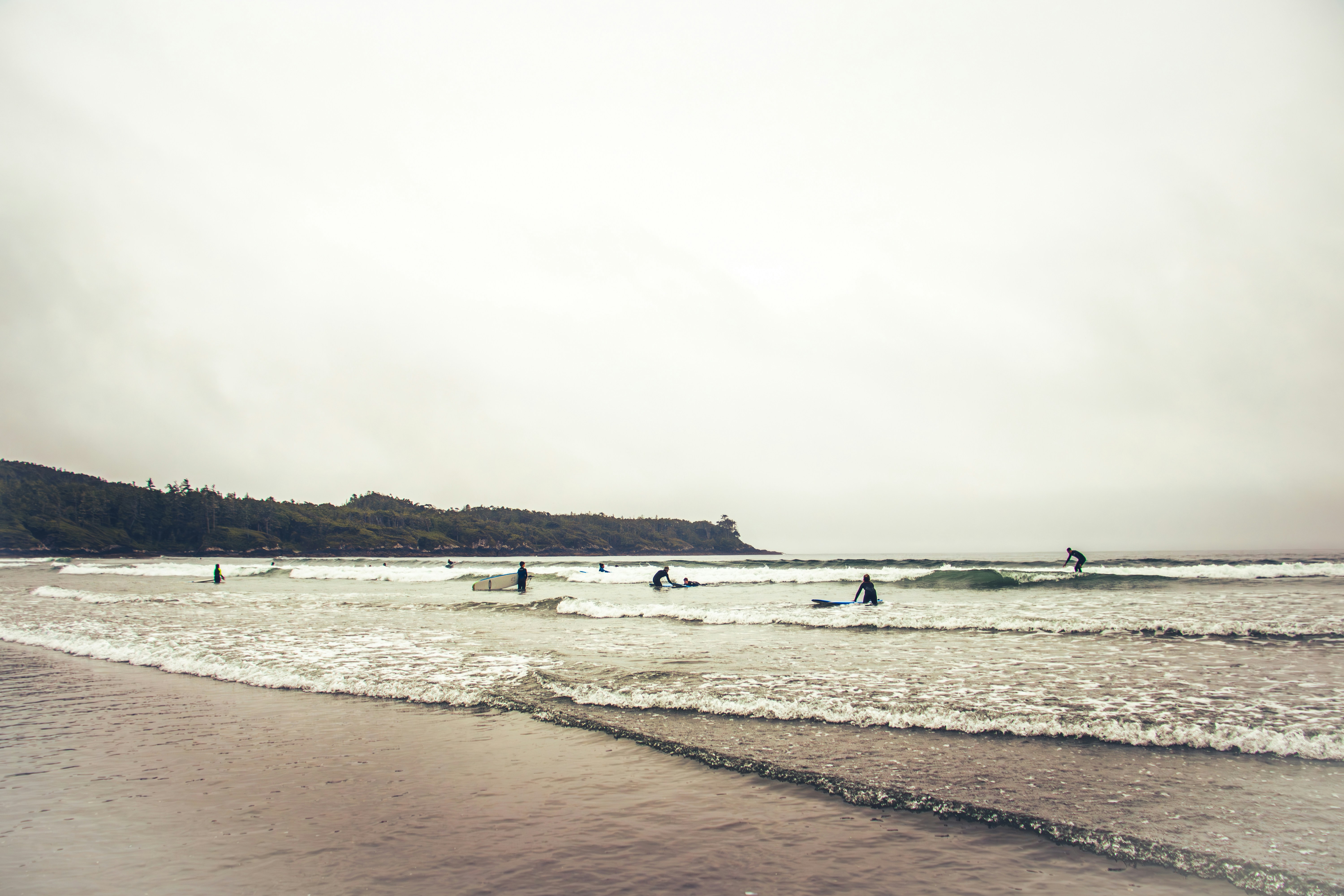 Dawn Palette: Surfers in a Quiet Seascape