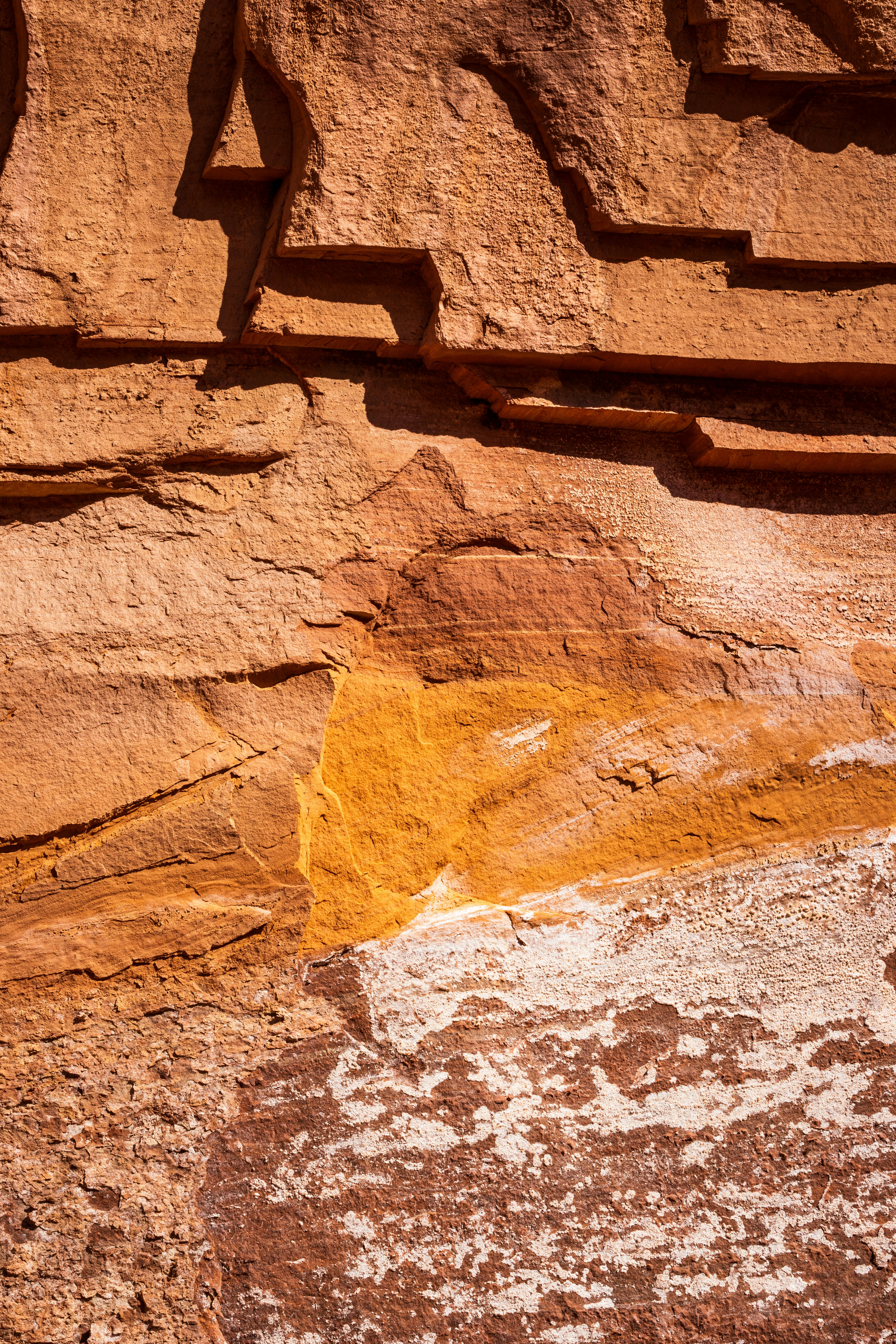 Crimson Strata: Weathered sandstone textures in sunlit relief
