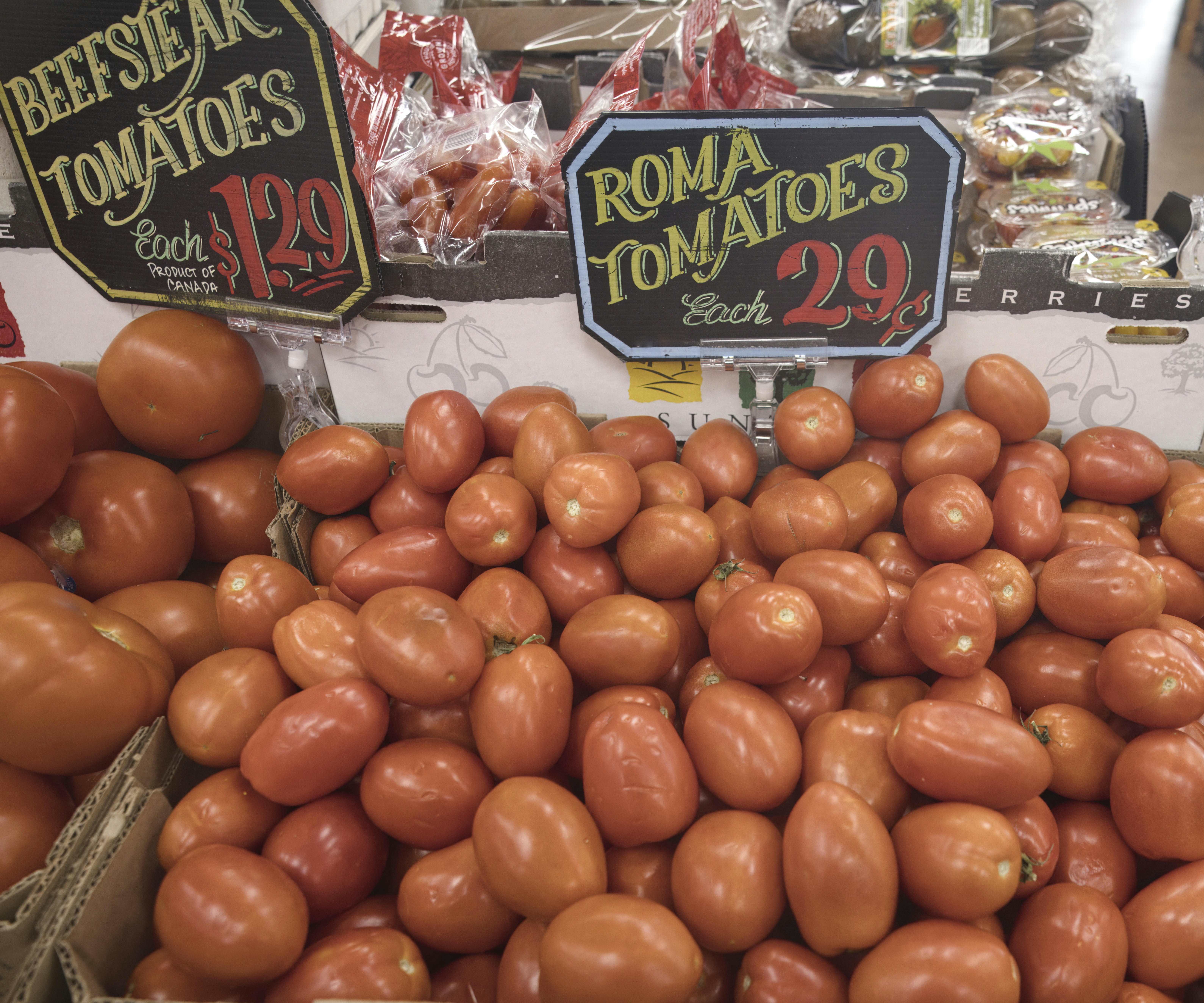 A display in a grocery store filled with lots of tomatoes photo – Free ...
