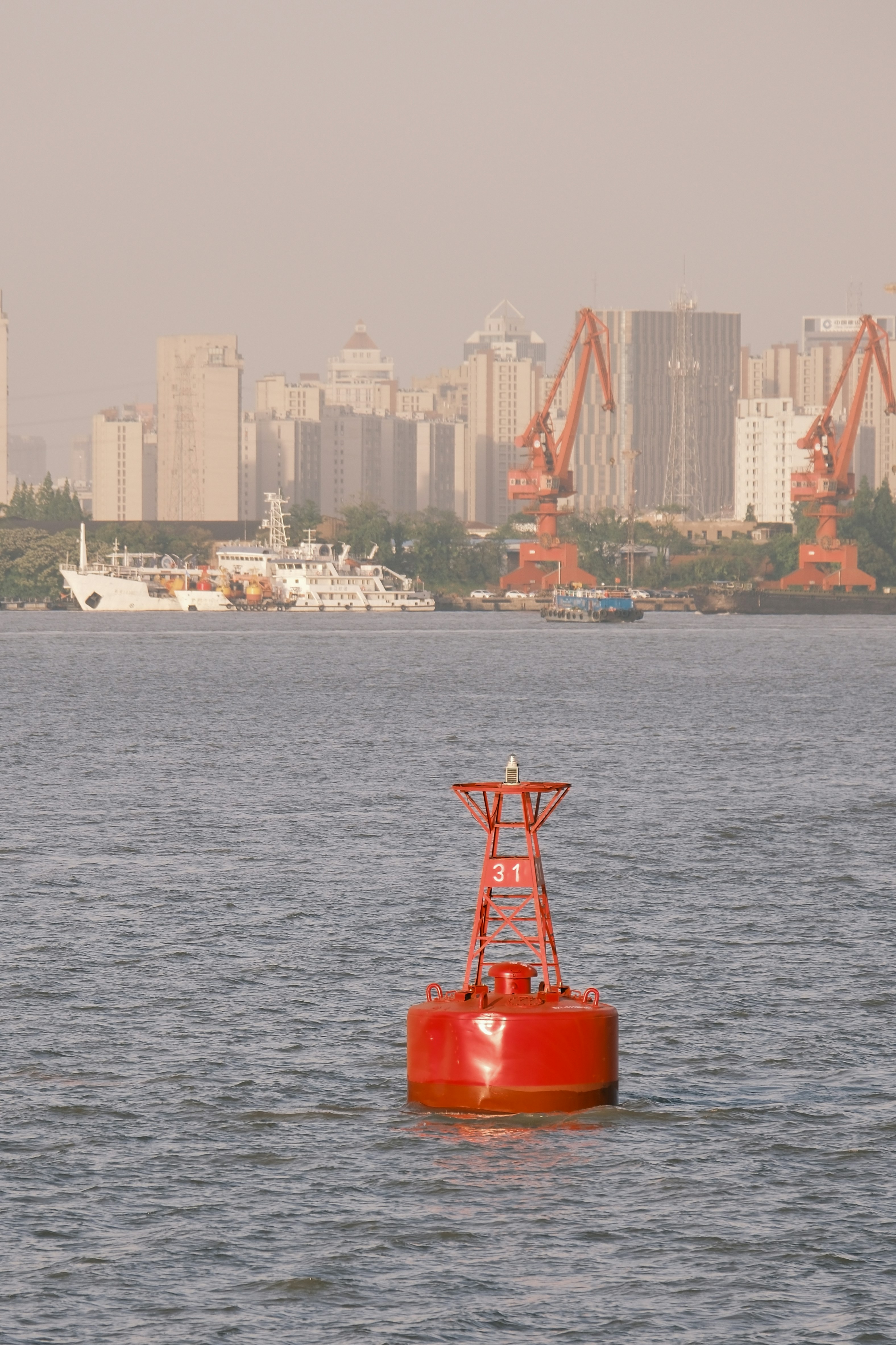 A red buoy floating on top of a body of water photo – Free Buoy Image ...