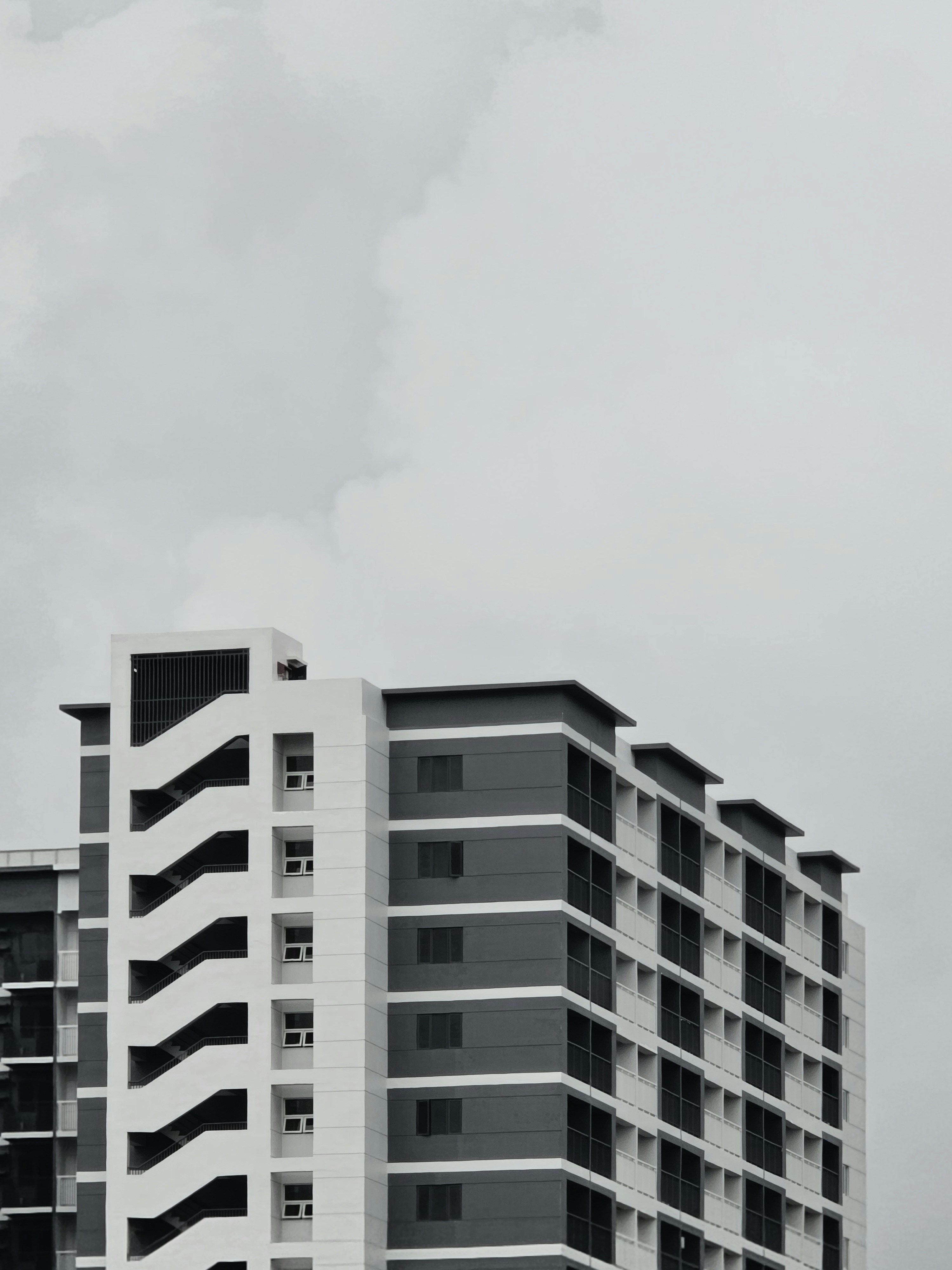 Monochrome Staircase Geometry: A Modern Block Reaches Toward the Sky