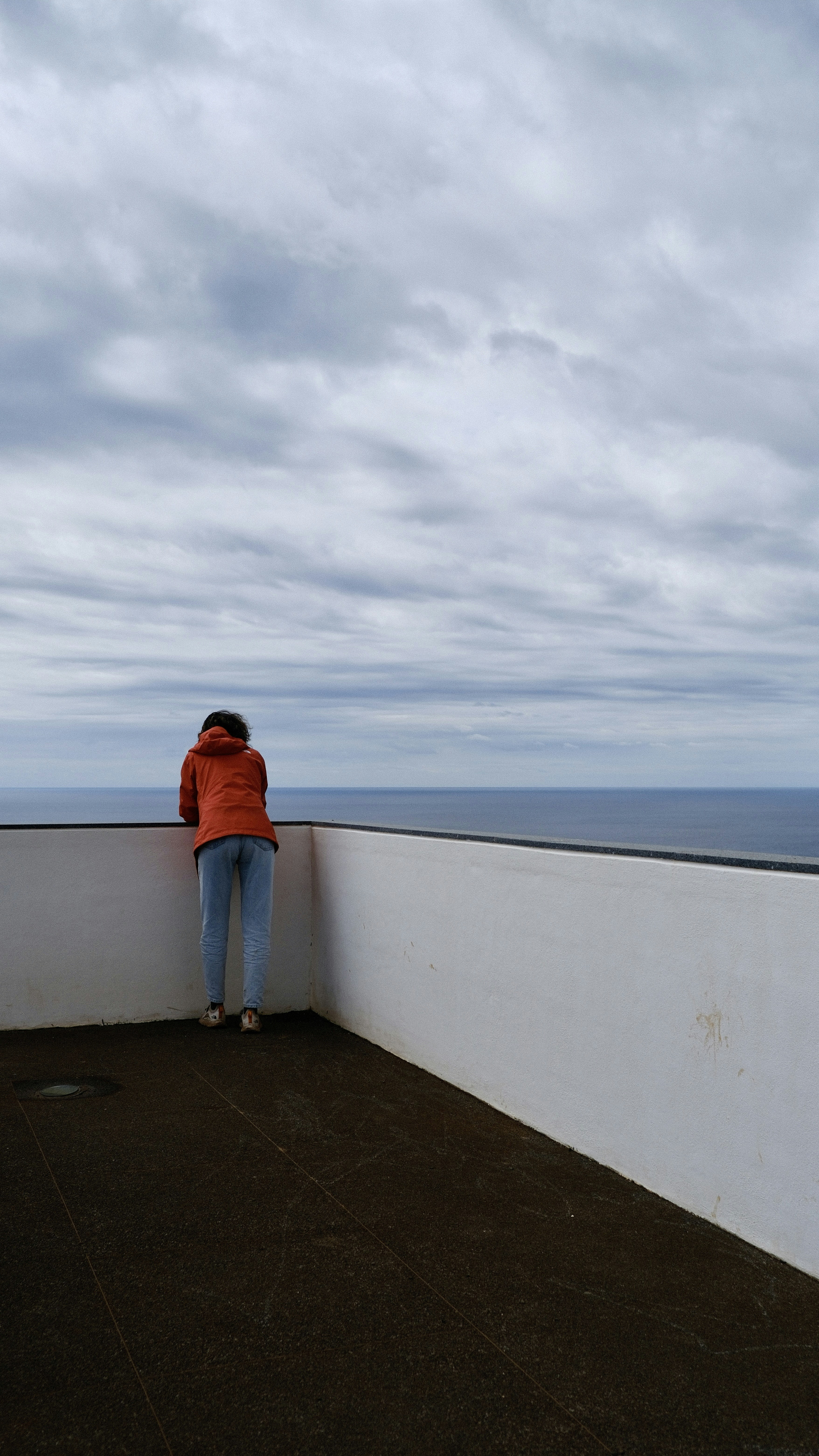 Red Coat at the Rail: A Quiet Gaze Over the Atlantic