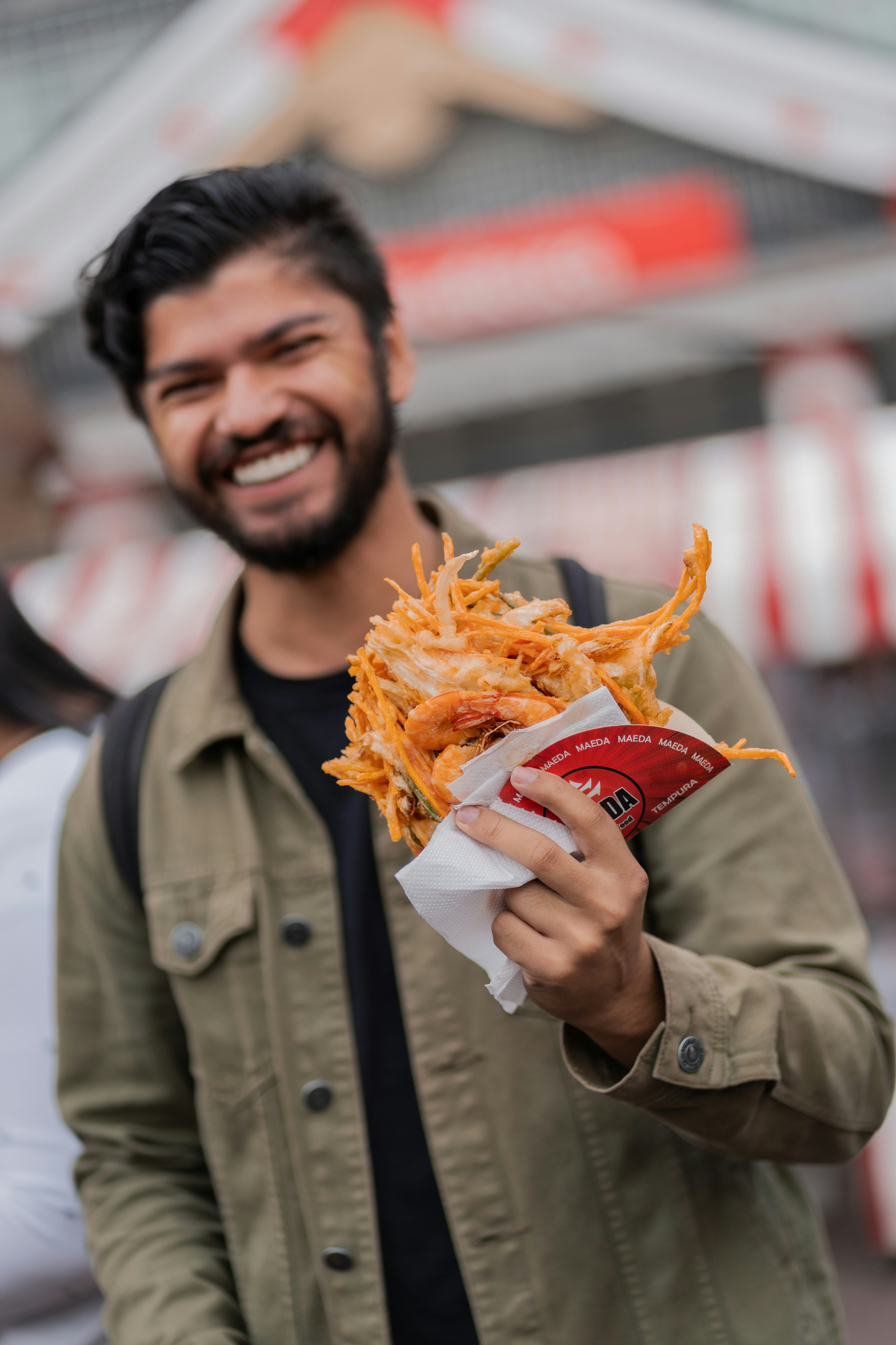 Smiling Street Vendor Grasping Crispy Chicken Curls
