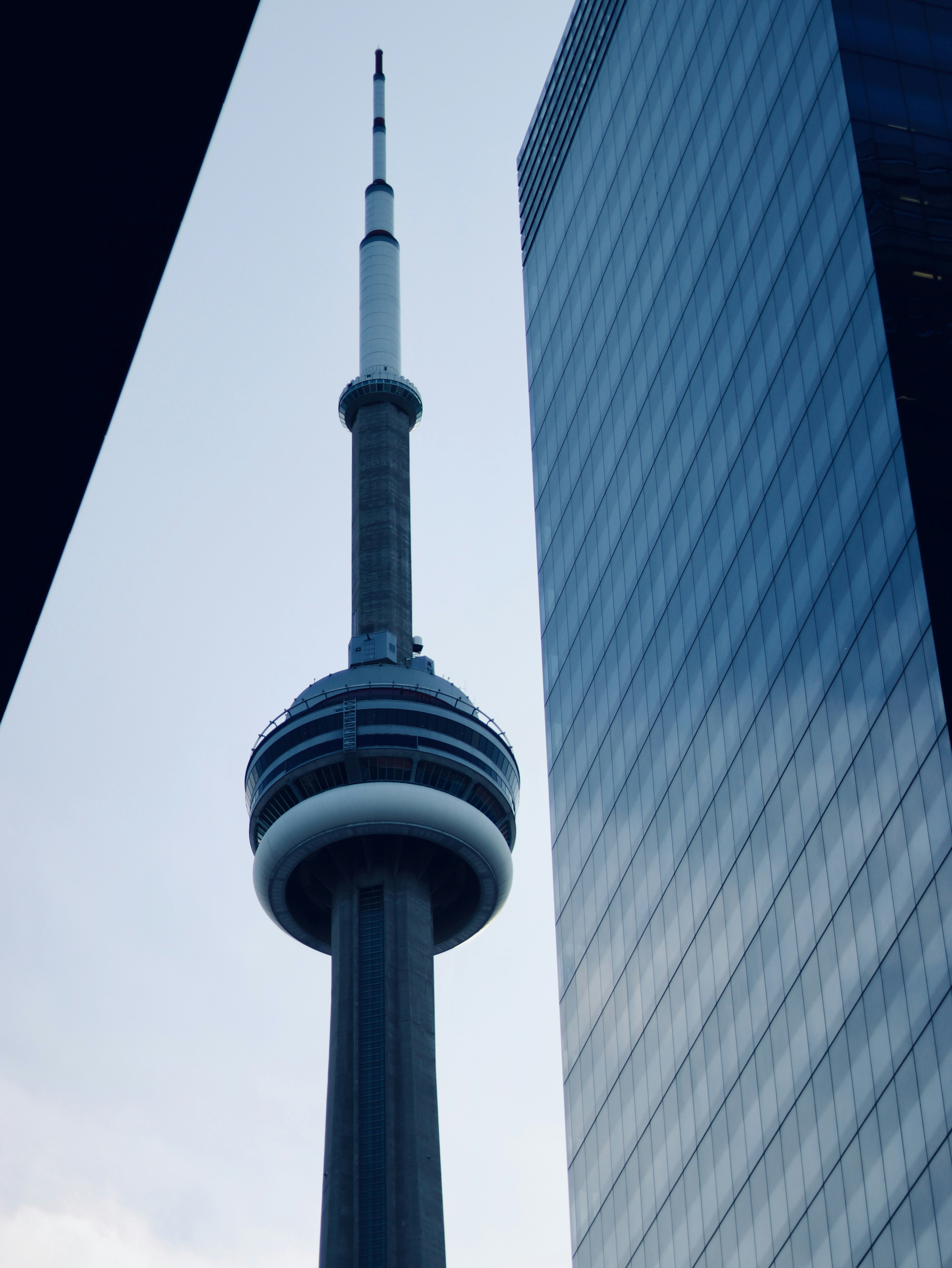 A tall tower with a sky scraper in the background photo – Free Building ...