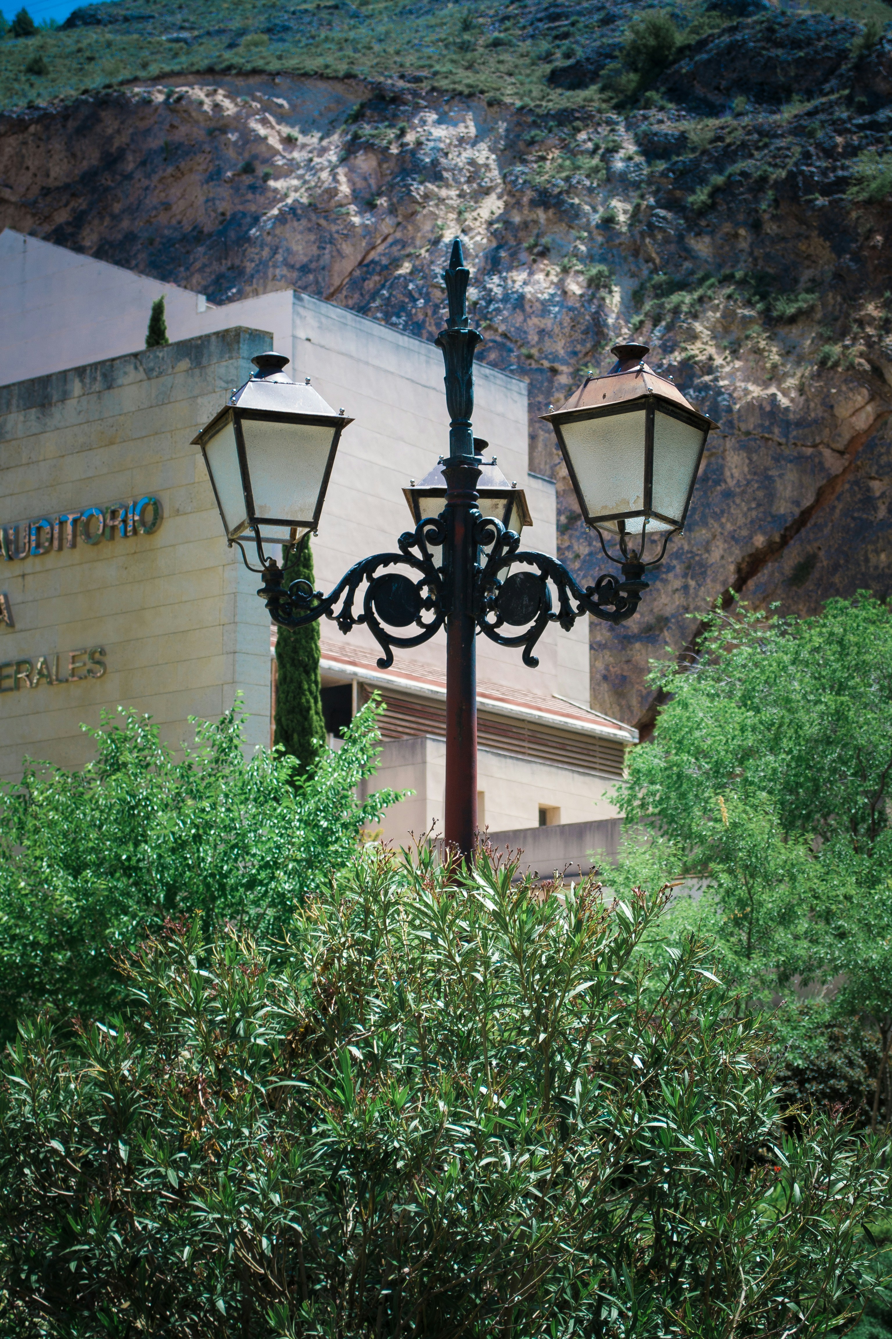 Iron Lanterns, Stone Facade, and Olive Hills