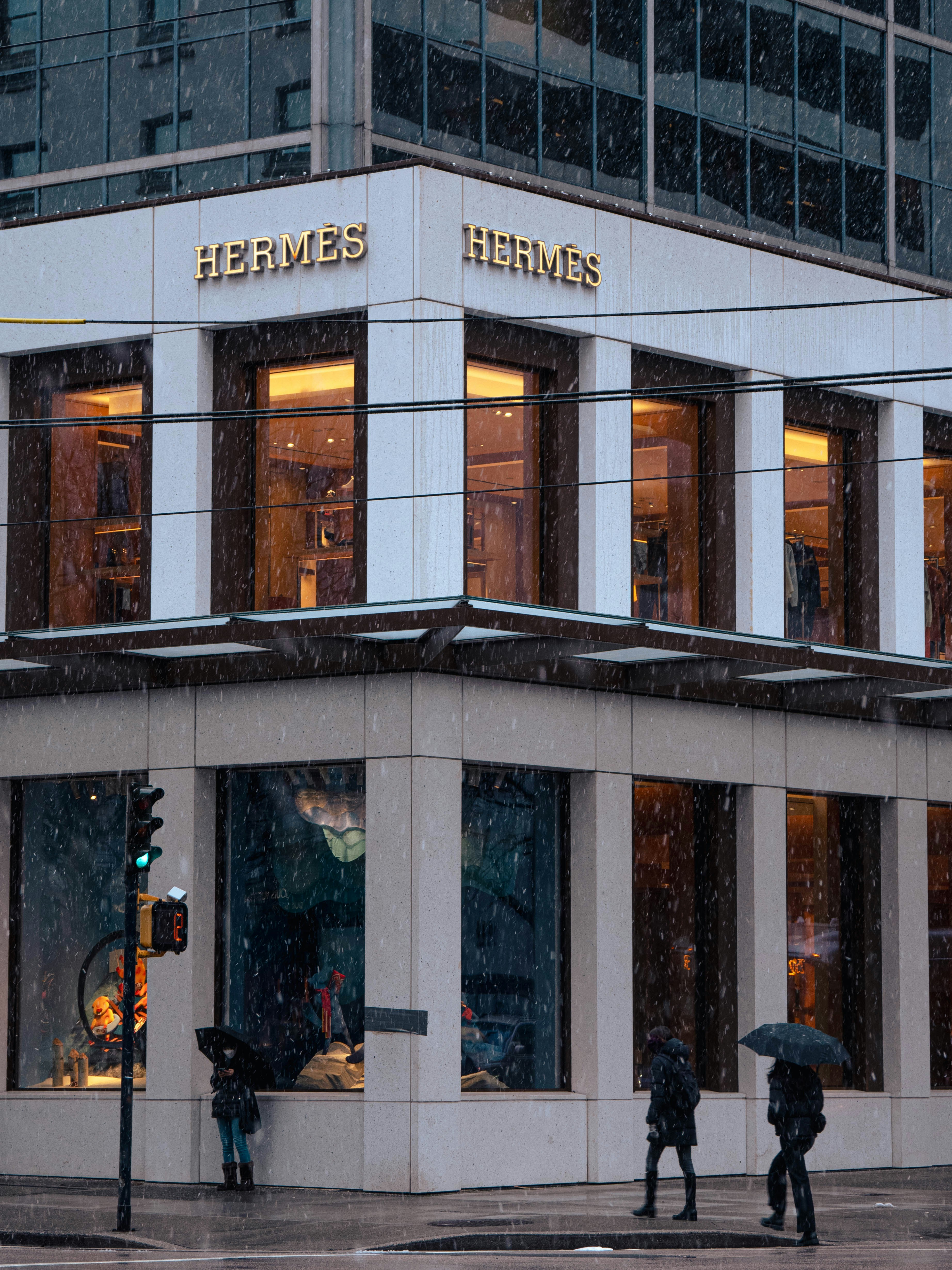 A couple of people that are standing outside of a building photo – Free ...