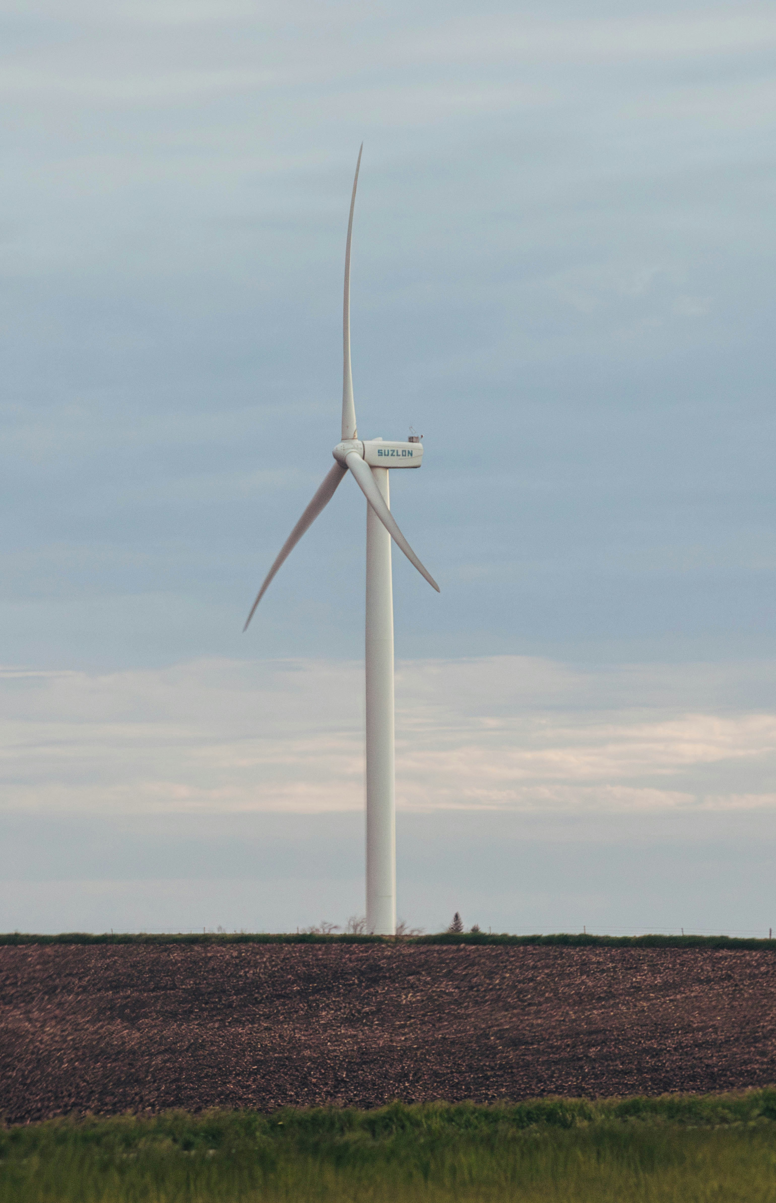 a wind turbine in the middle of a field