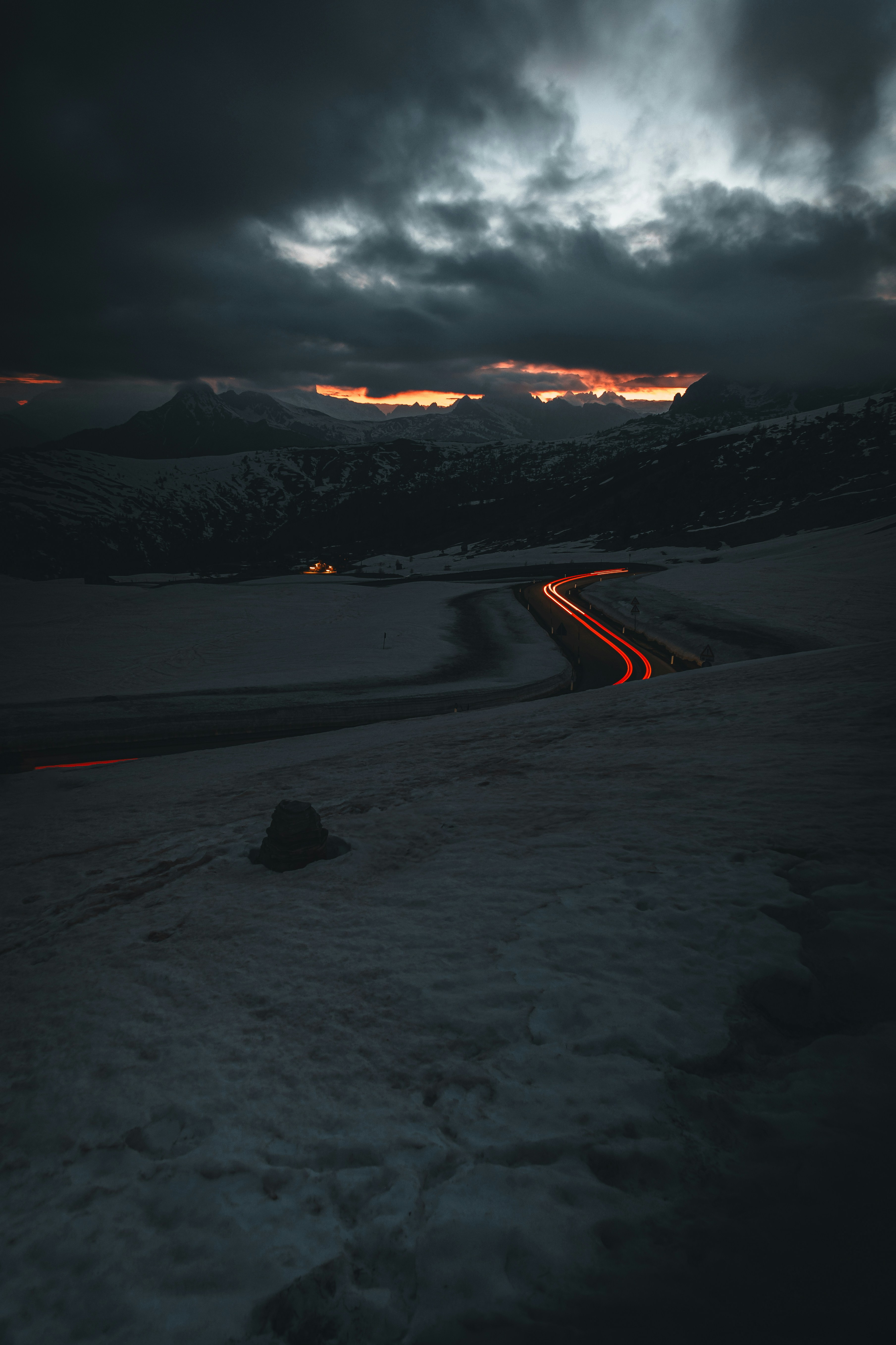 a road that is in the middle of some snow