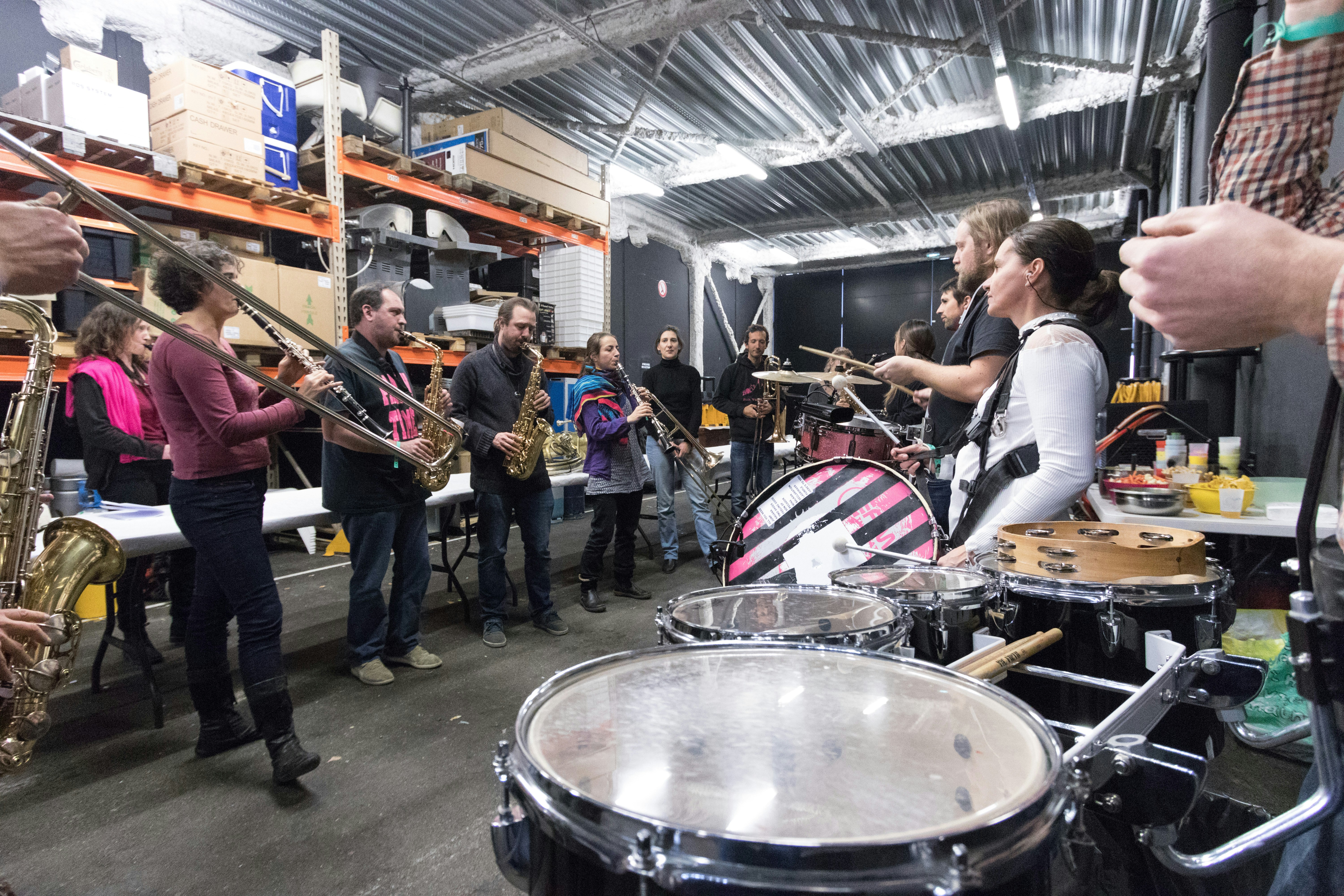A group of people playing instruments in a room photo – Free Brass band ...