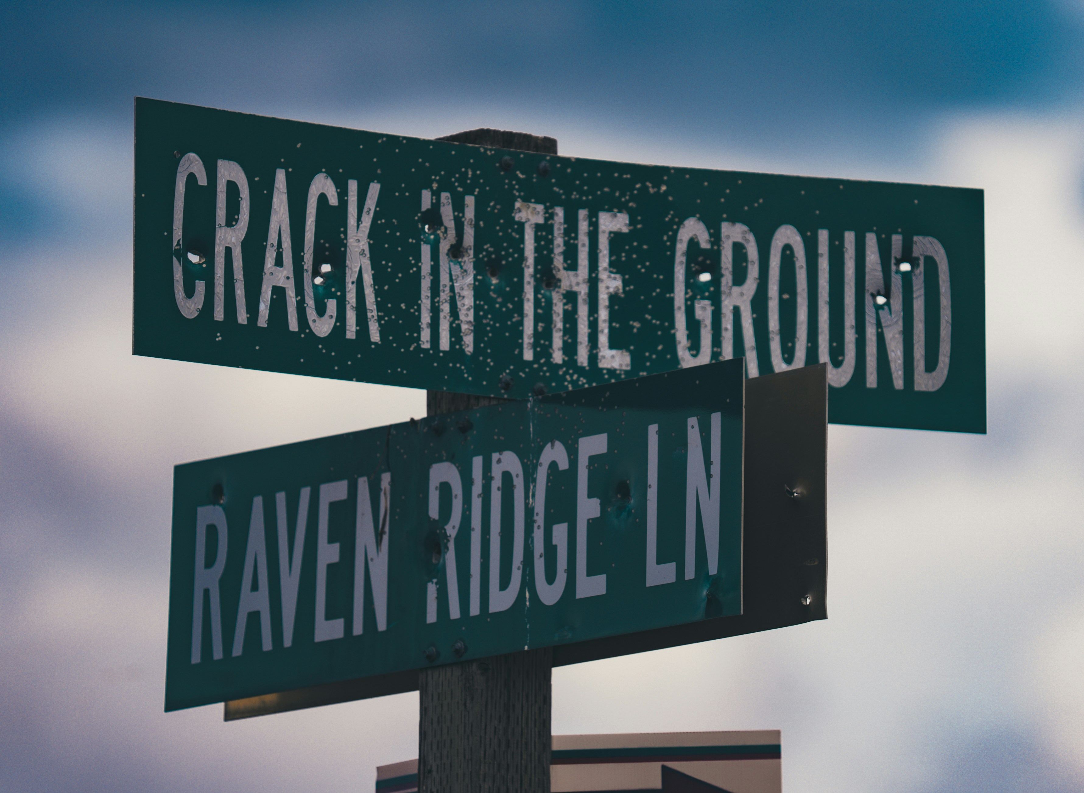 A couple of green street signs sitting on top of a wooden pole photo ...