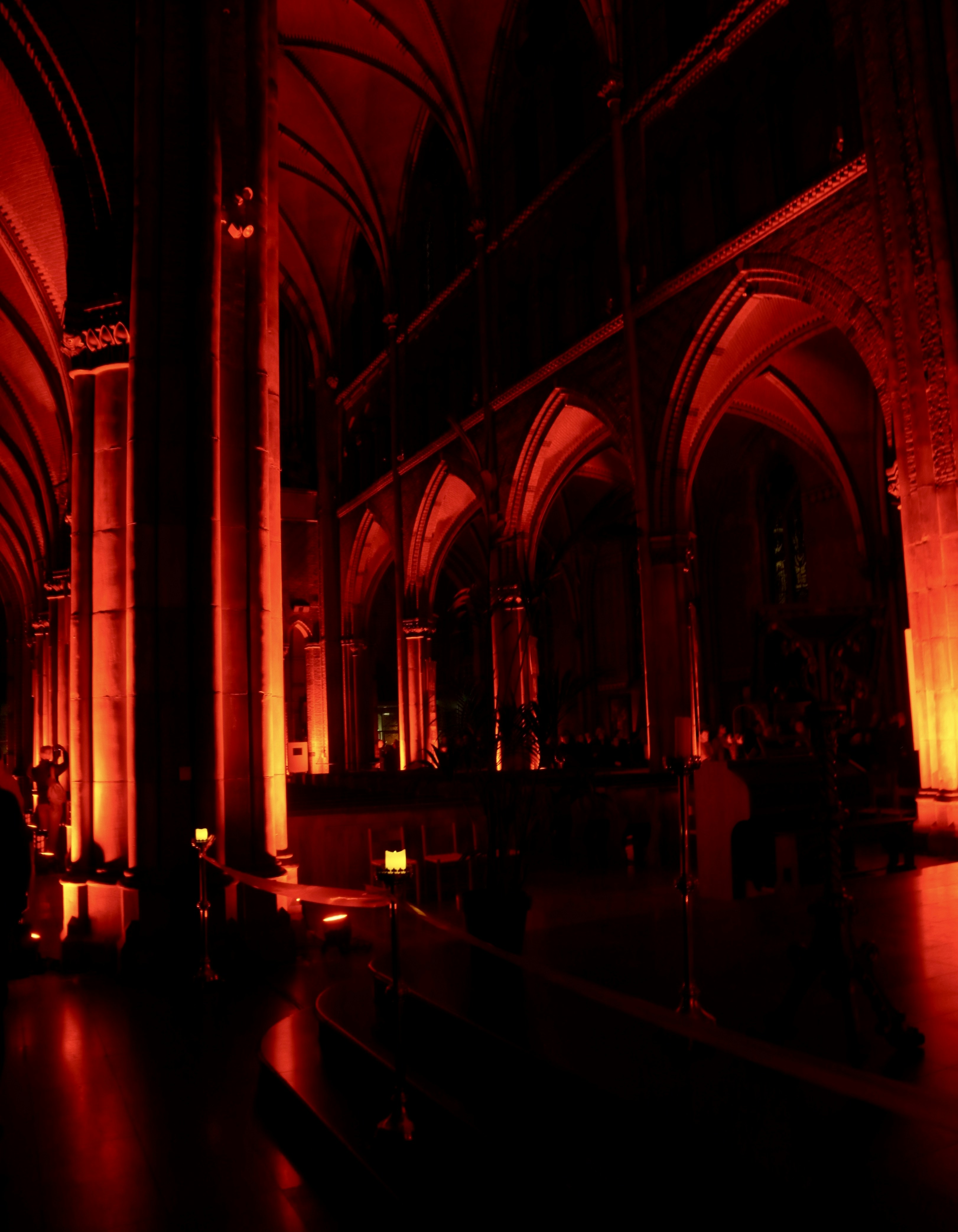 A dimly lit cathedral with red lighting photo – Free Light Image on ...