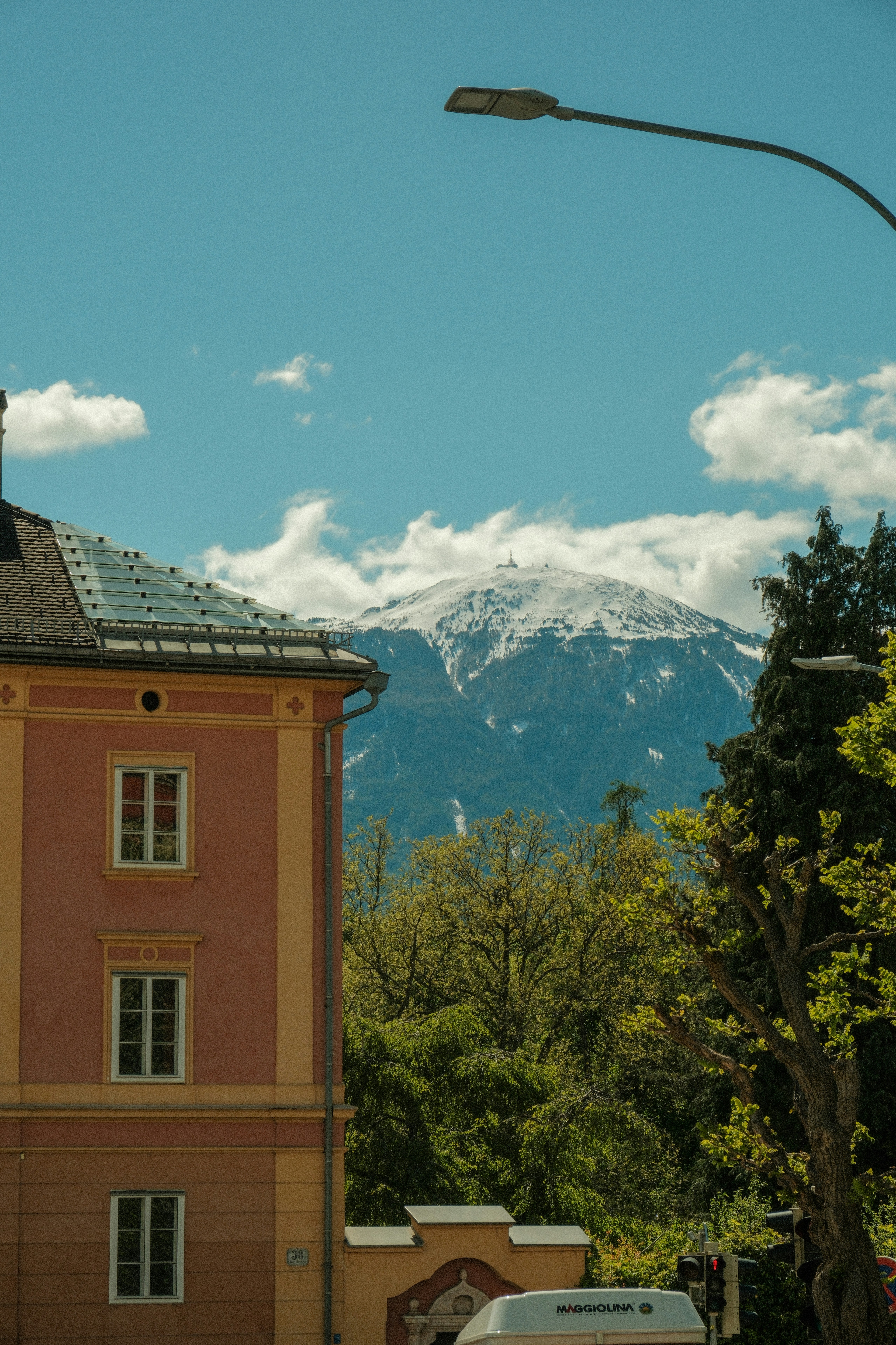 Snow-Capped Peak Framing a Peach-Colored Urban Facade