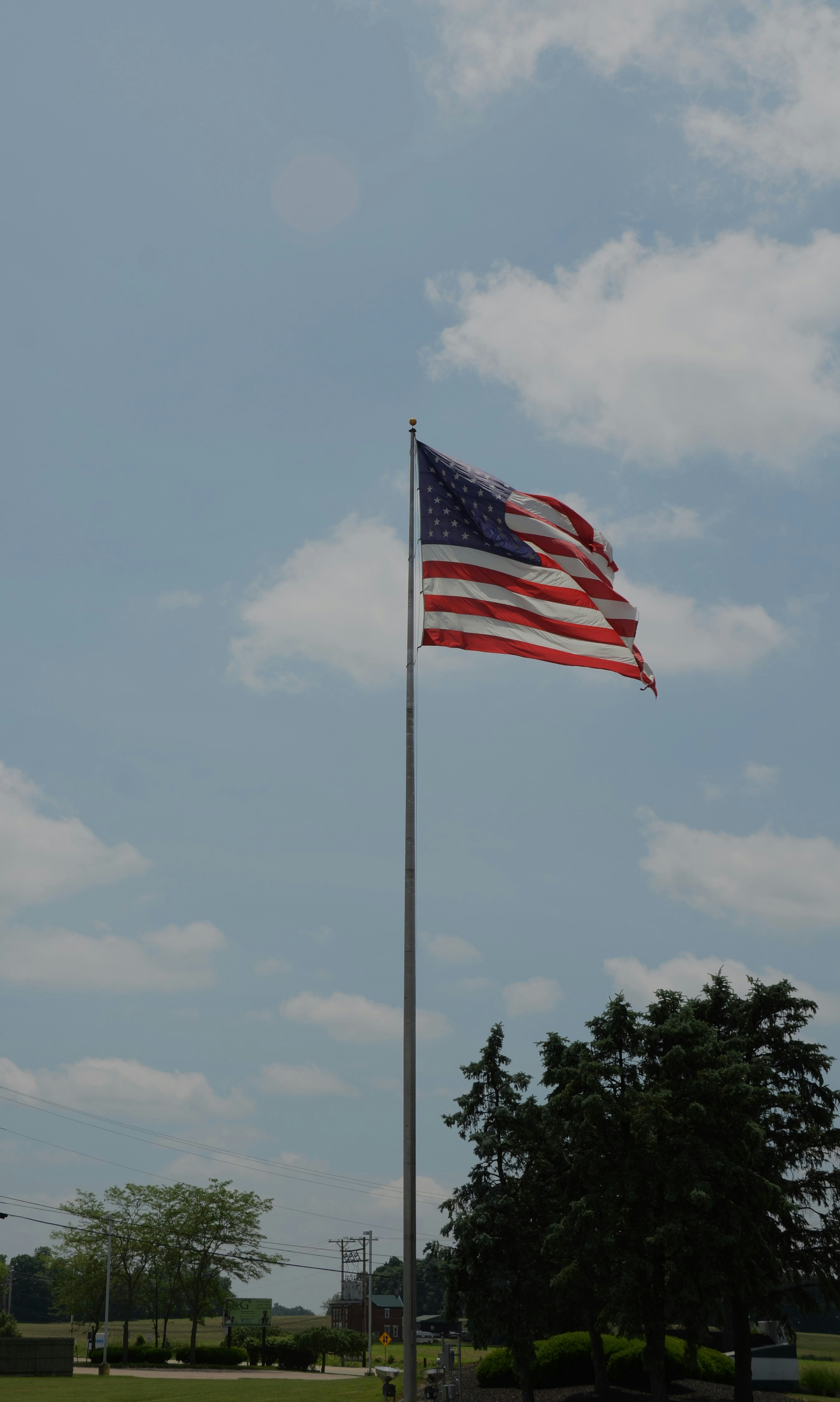 An american flag is flying high in the sky photo – Free Grey Image on ...