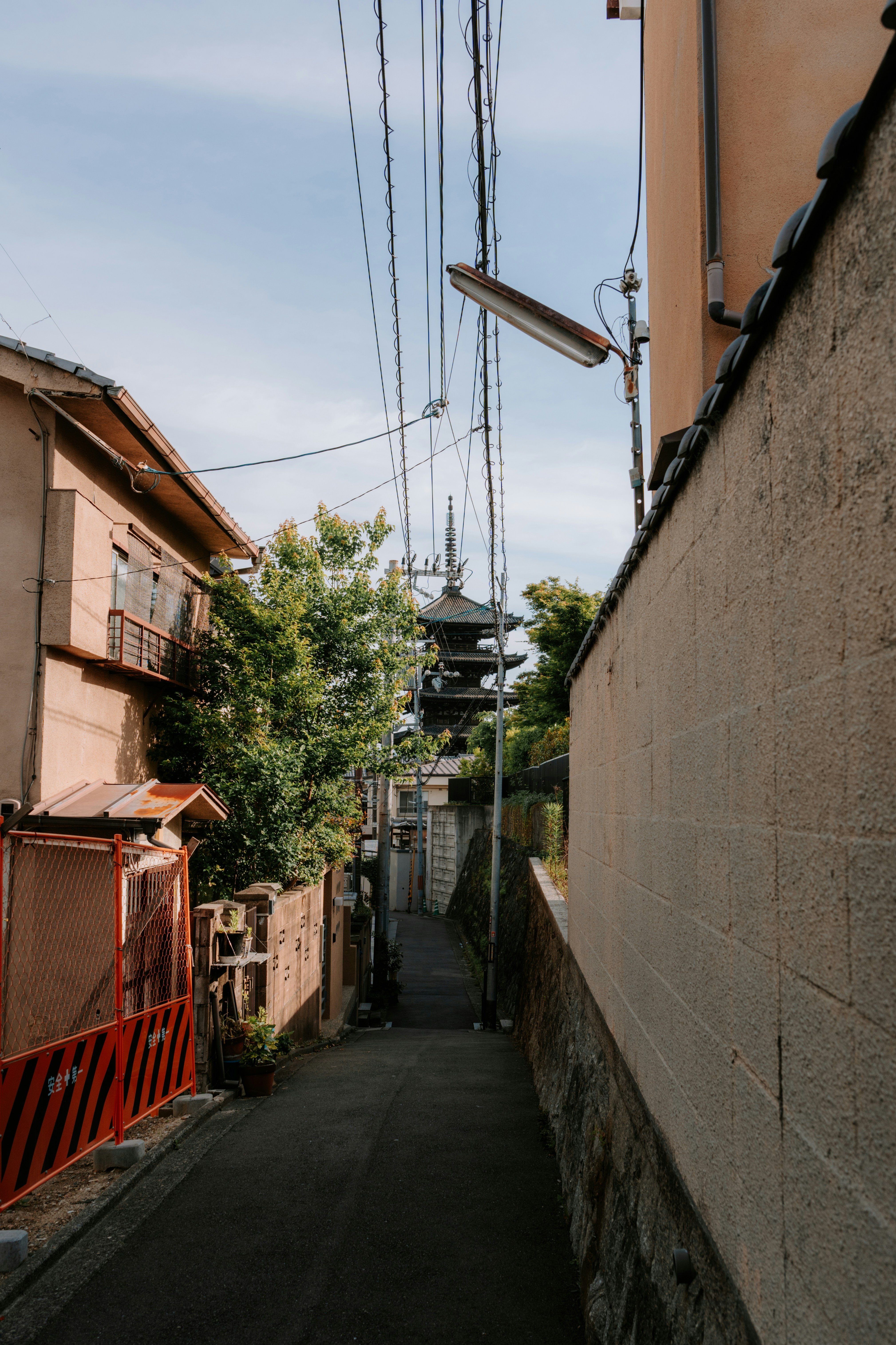 Alley Convergence: Wires, Walls, and a Distant Pagoda