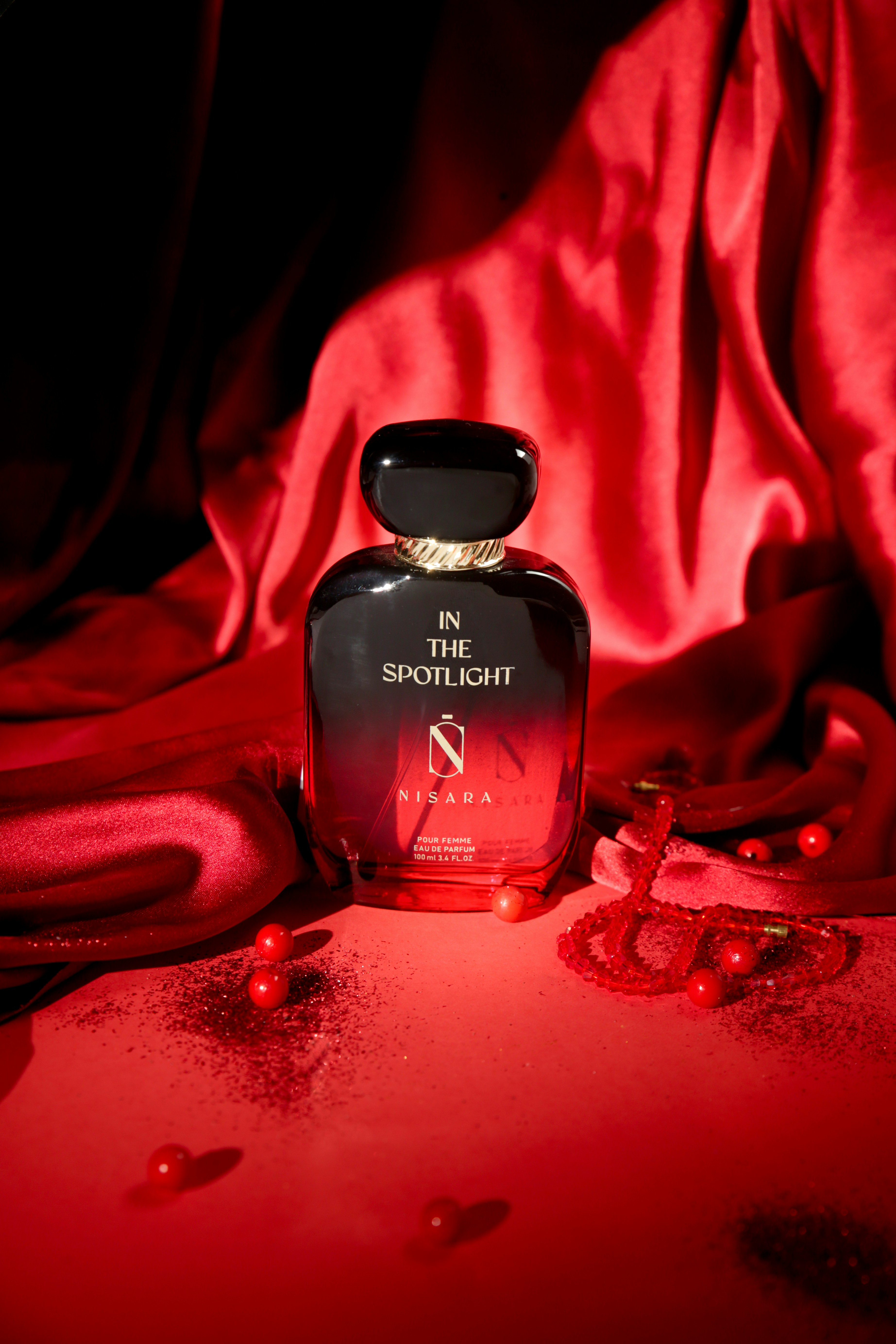 A bottle of perfume sitting on top of a red cloth photo – Free Bottle ...