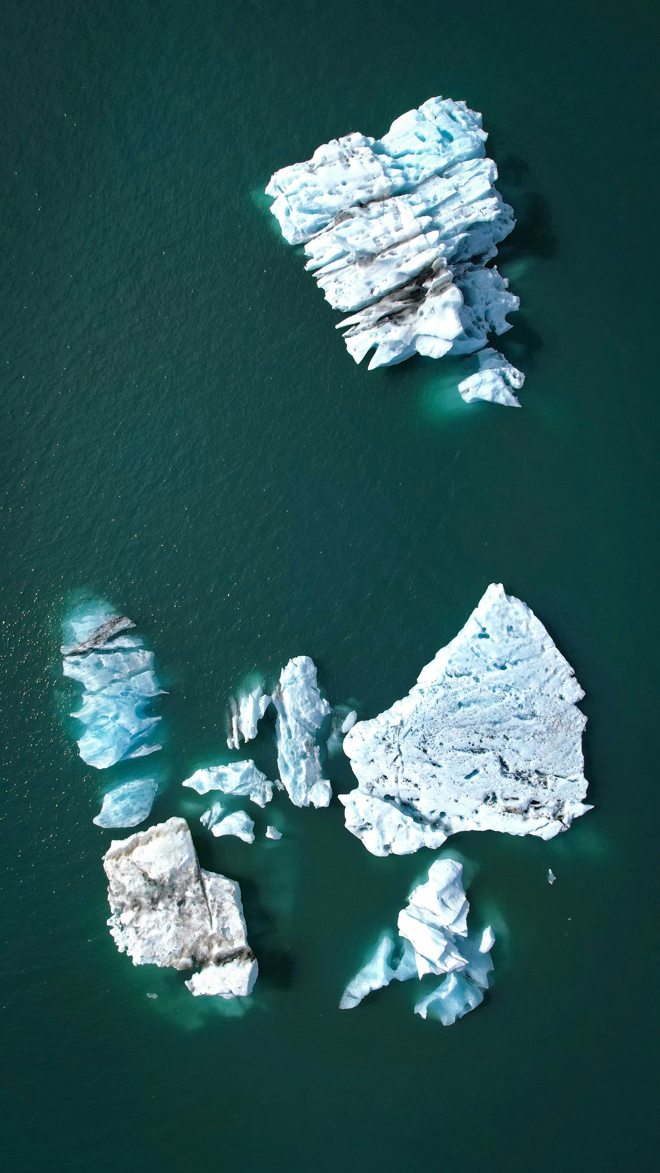 Teal Ice Floes: An Aerial Portrait of Floating Glacial Fragments